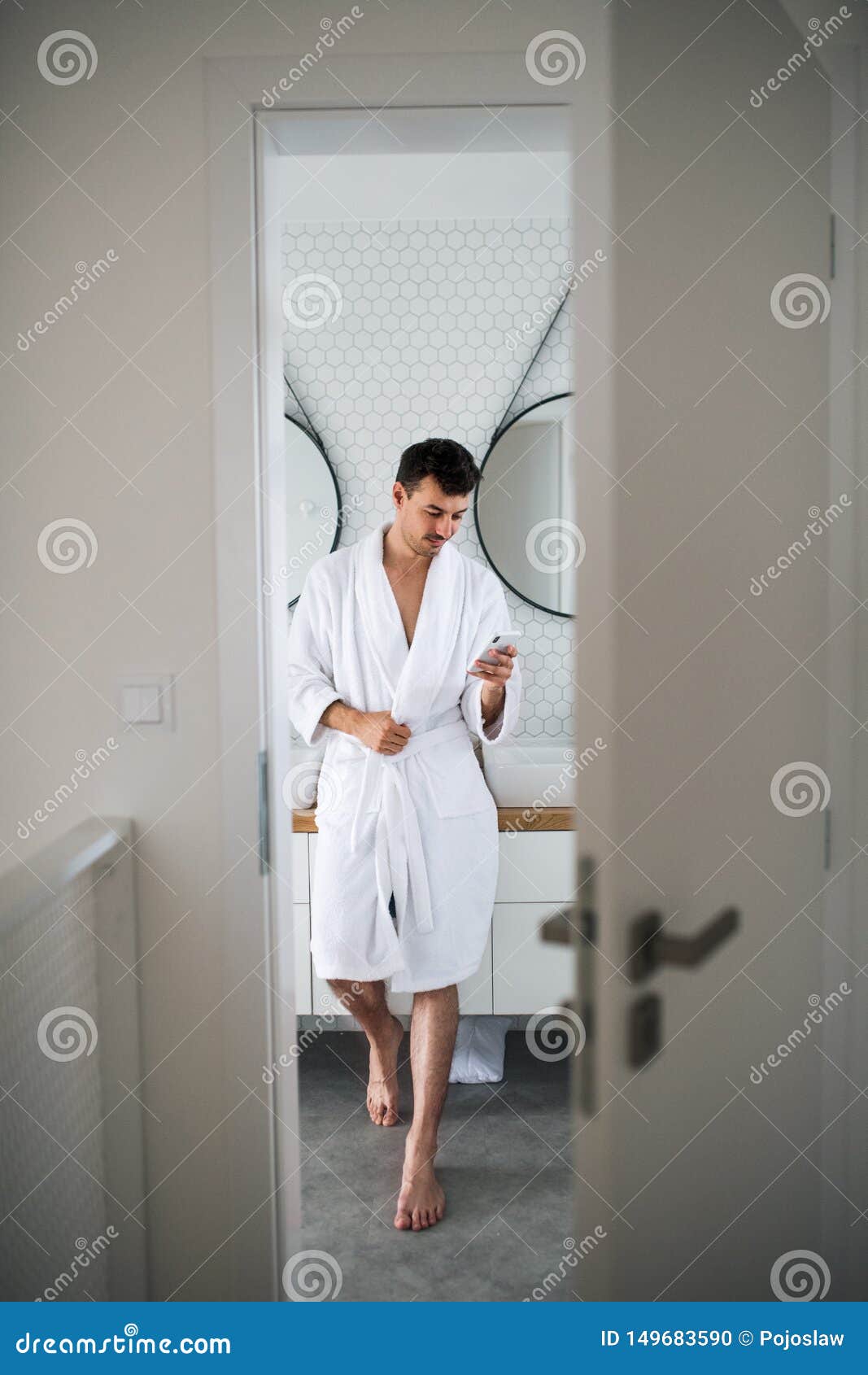 Young Man with Smartphone in the Bathroom in the Morning. Stock Photo ...