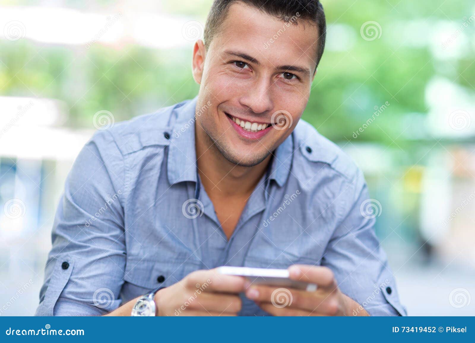 Young man with smartphone stock photo. Image of cell - 73419452