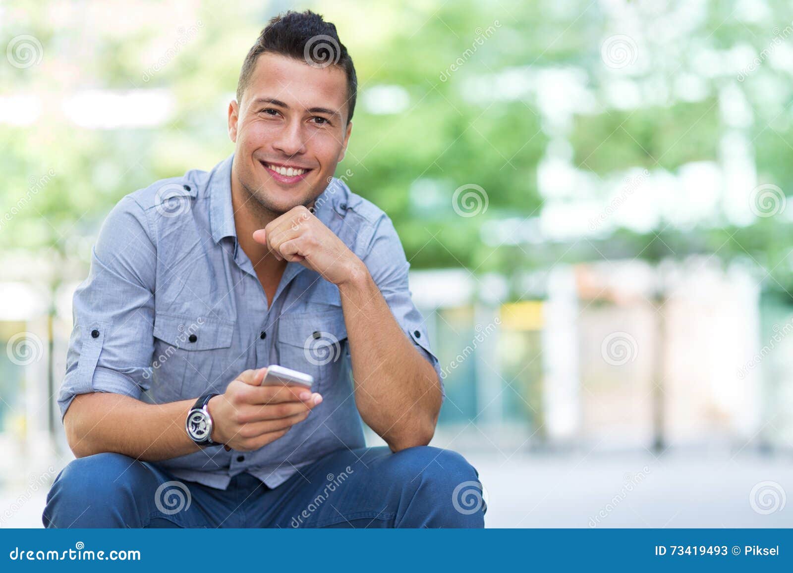 Young man with smartphone stock image. Image of toothy - 73419493