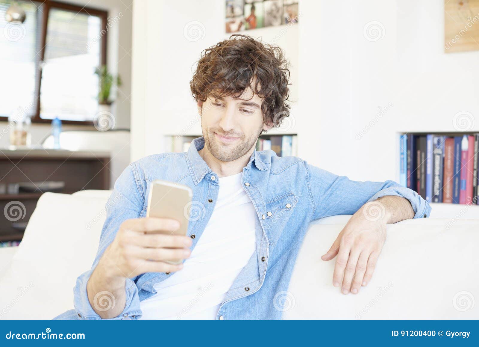Young man with smartphone stock photo. Image of relaxing - 91200400