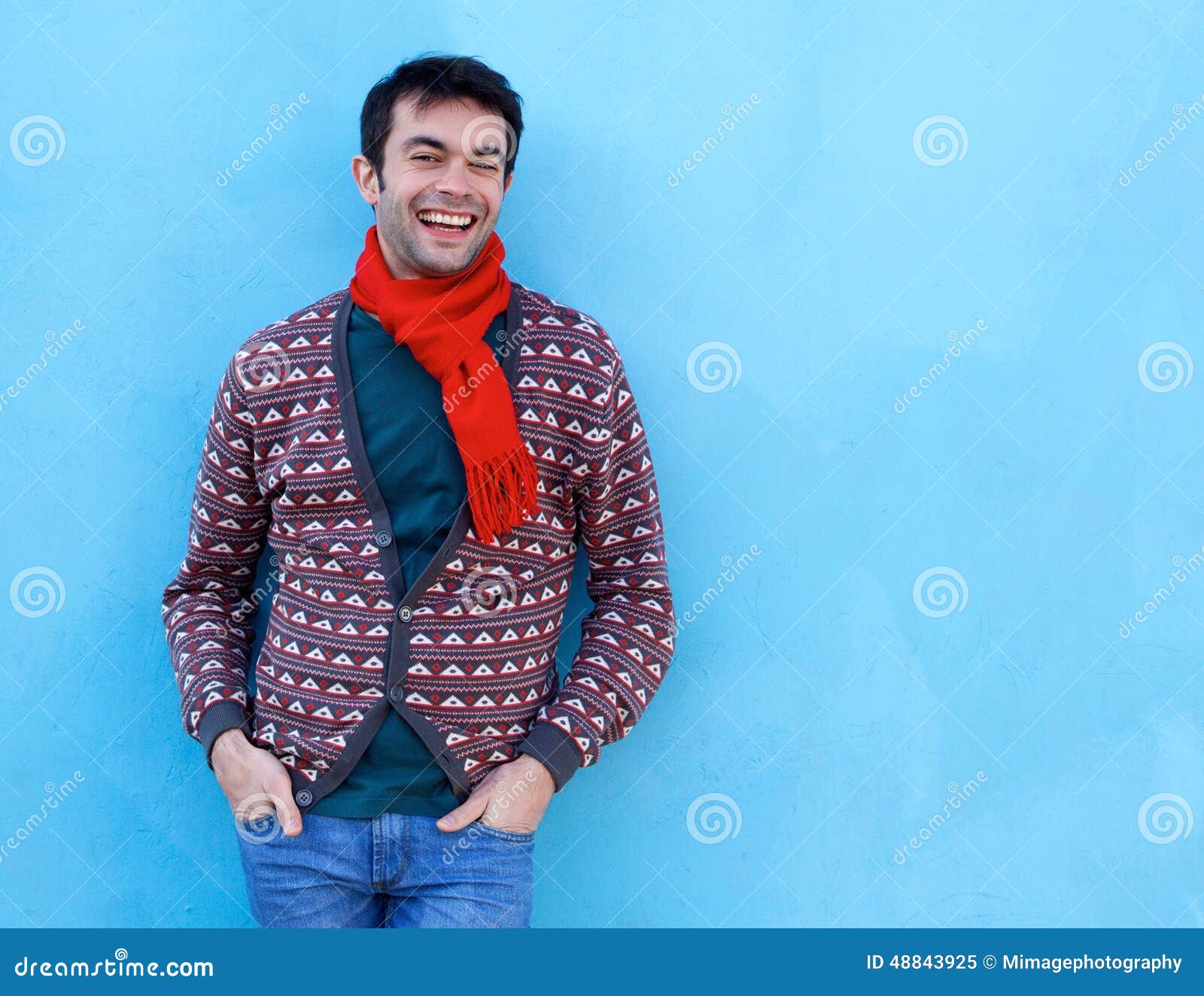 Young Man Smiling Against Blue Background Stock Image - Image of face ...
