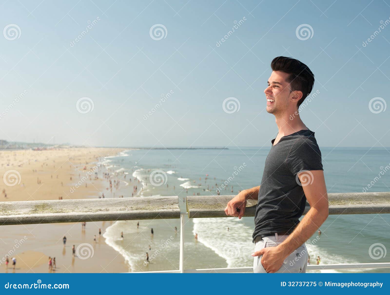 Young Man Smiling at the Beach Stock Image - Image of leaning, relax ...