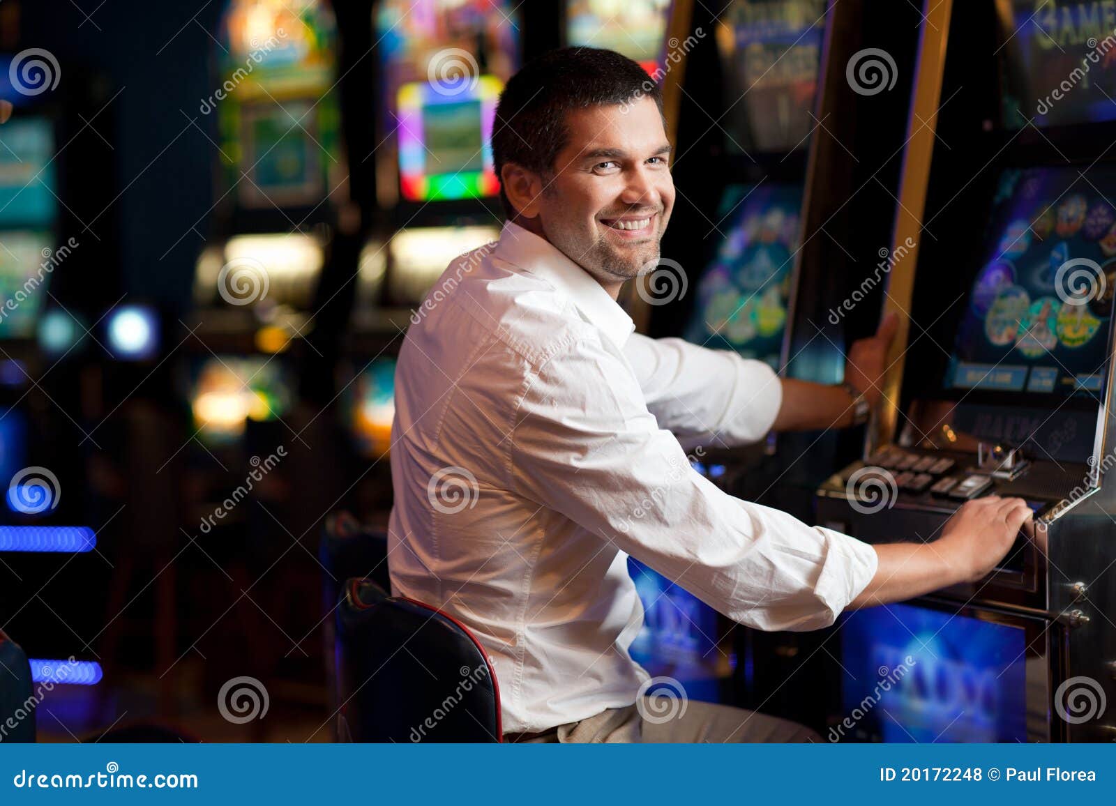 Young Man Smiling Next To the Slot Machine Stock Photo - Image of ...