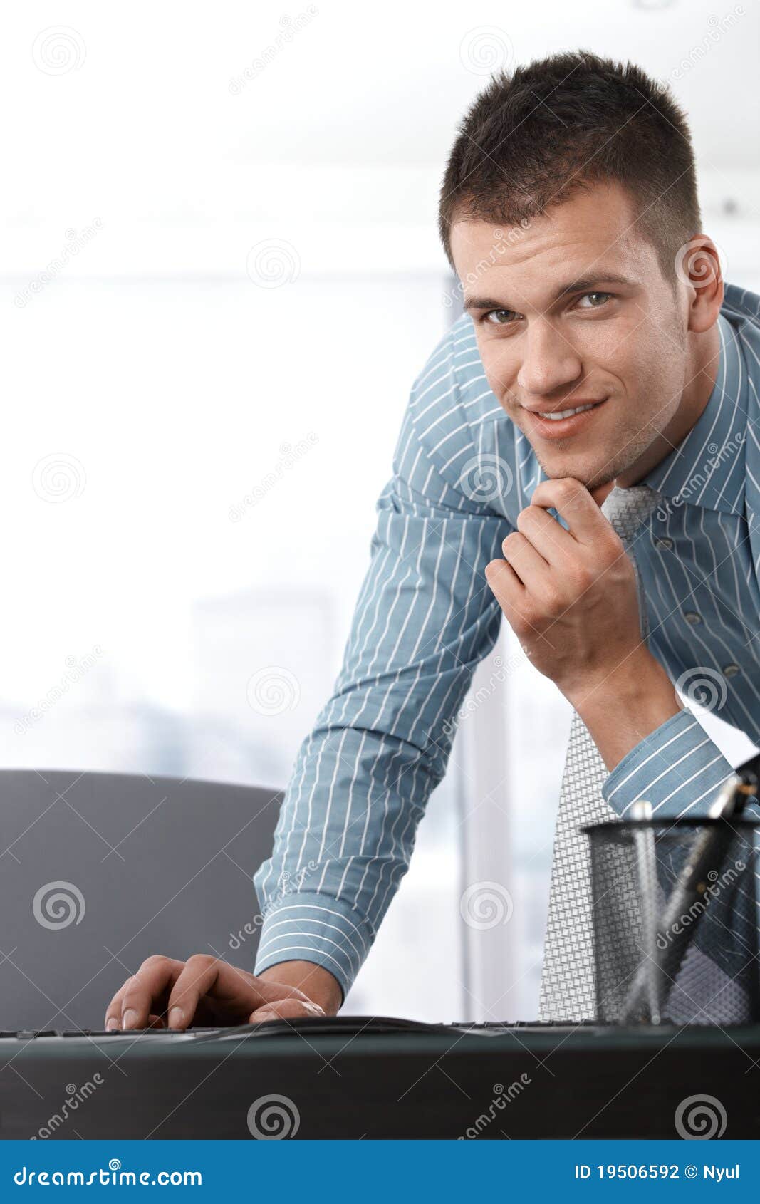 Young Man Smiling in Office Stock Photo - Image of businesspeople ...