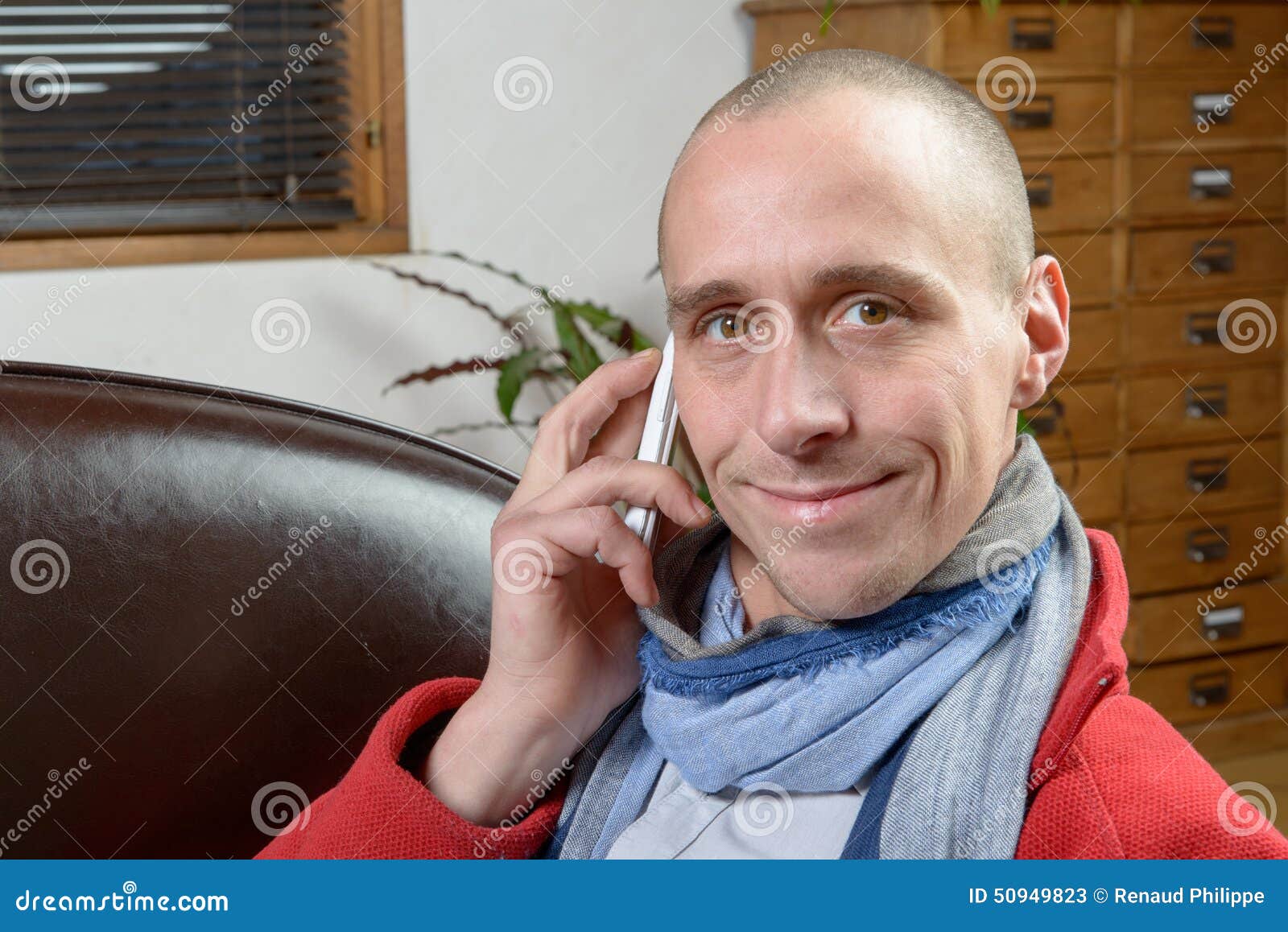 A Young Man Smiling with a Phone Stock Image - Image of casual ...