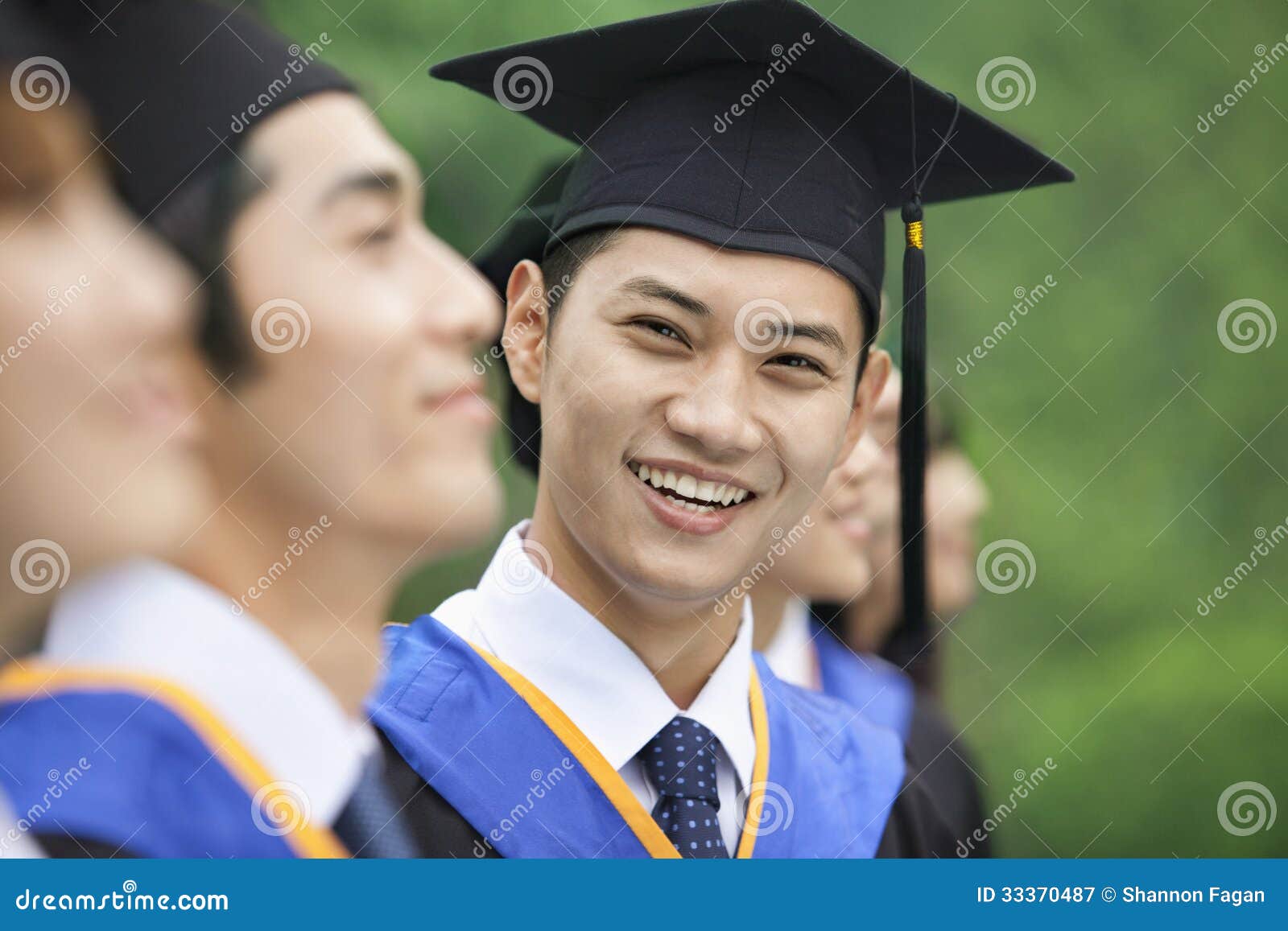 Young Man Smiling in a Row of Young University Graduates Stock Image ...