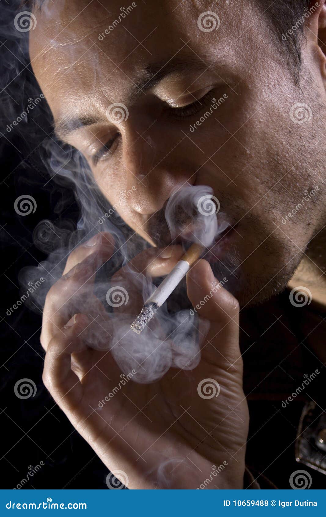 Young Man Smoking a Cigarette Stock Photo - Image of habit, black: 10659488