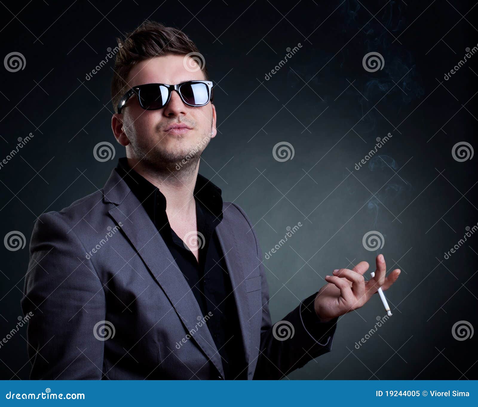 Young Man Smoking a Cigarette Stock Image - Image of background ...