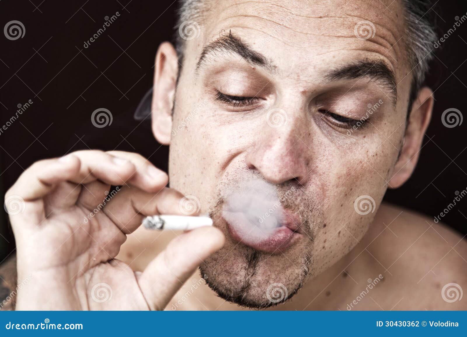 Young Man Smoking a Cigarette Stock Photo - Image of frown, edgy: 30430362