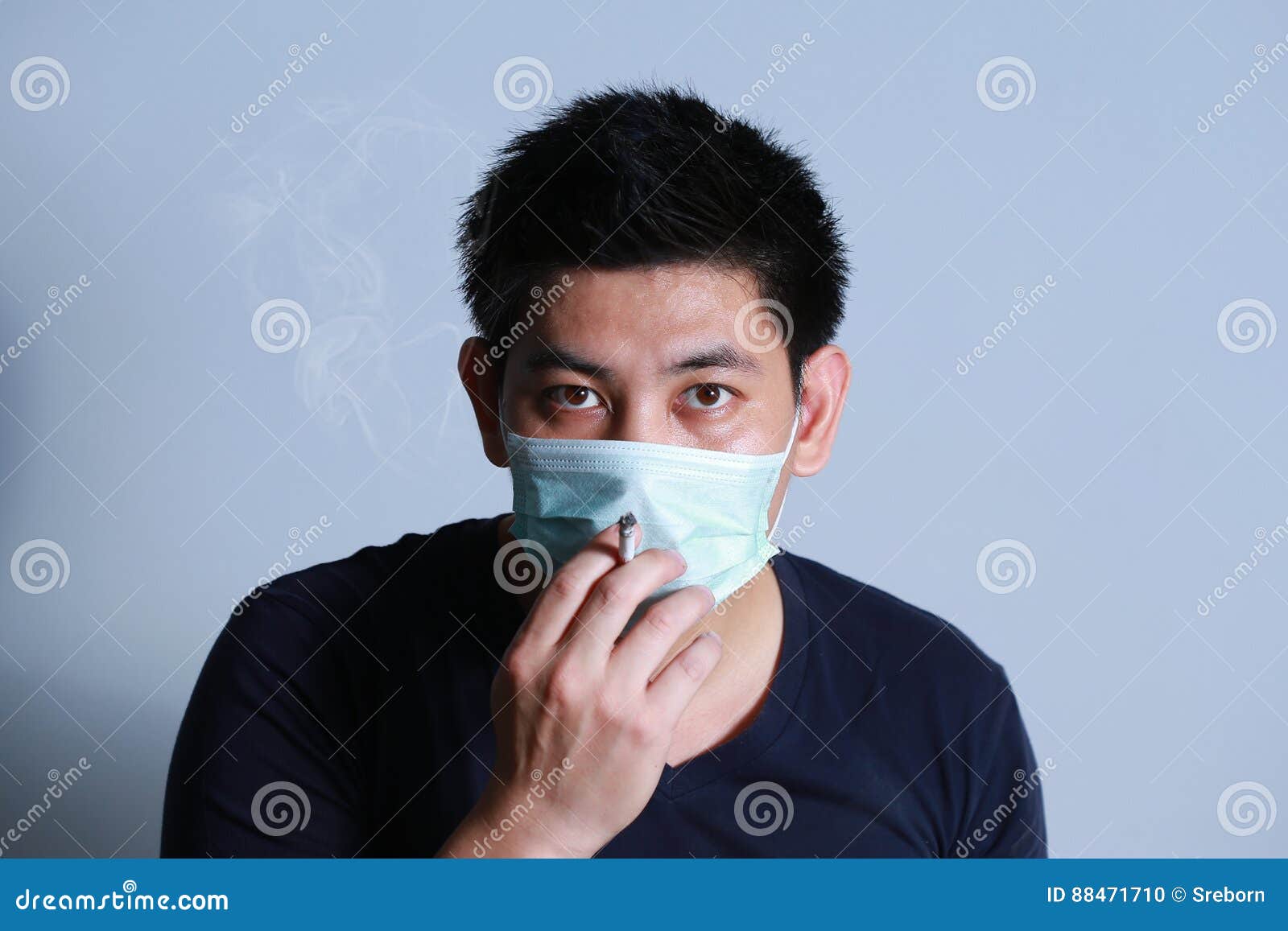 Young Man Smoking Cigarette with Protective Mask Stock Photo - Image of ...