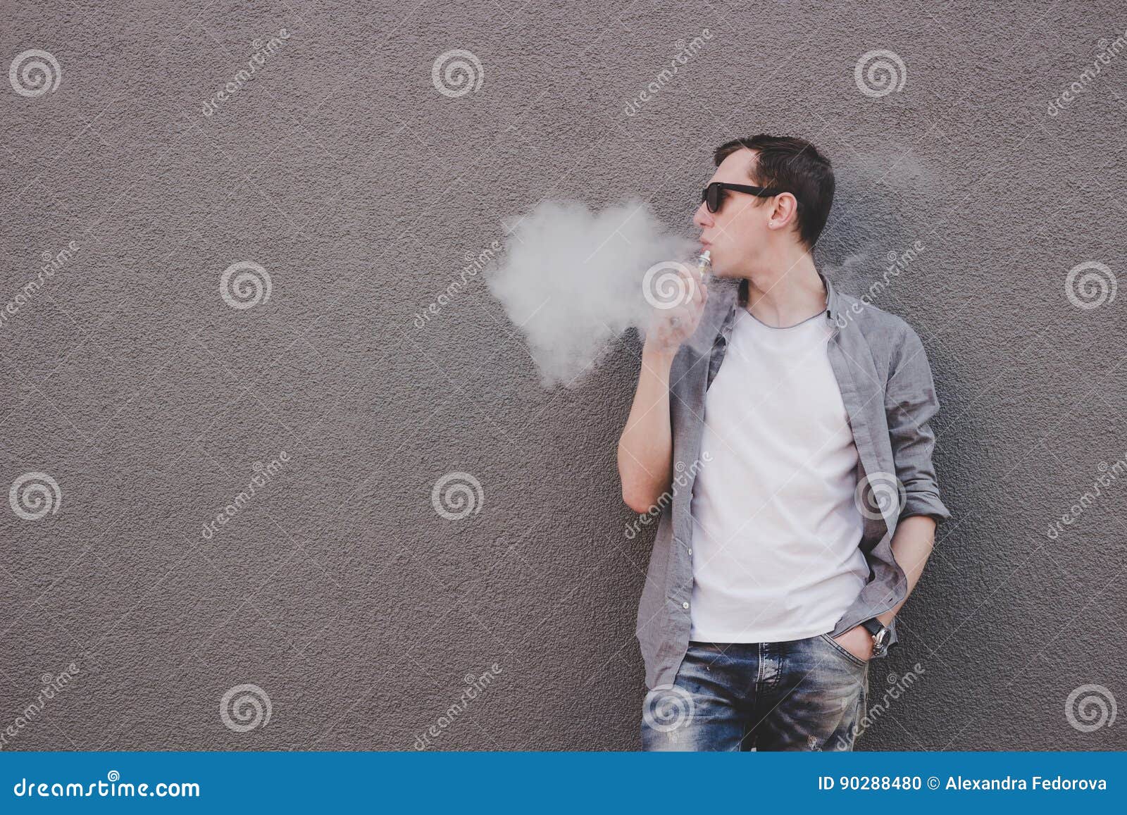 Young Man Smoking, Vaping Electronic Cigarette or Vape. Gray Background ...