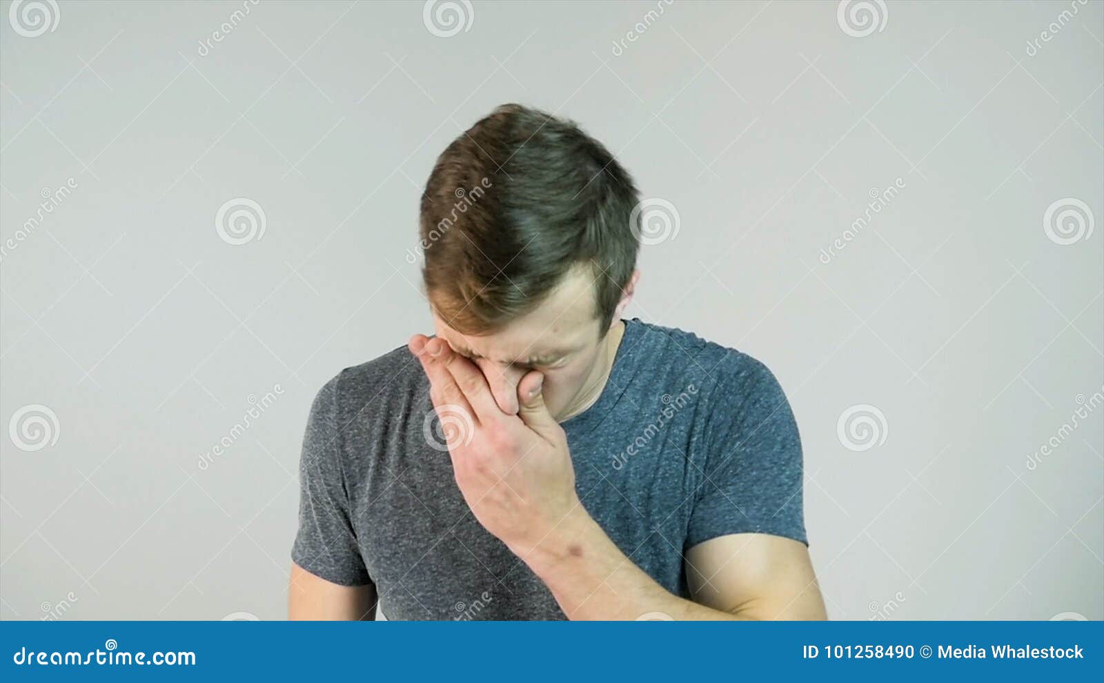 Young Man Sneezing on a White Background, Slow Motion Stock Photo ...