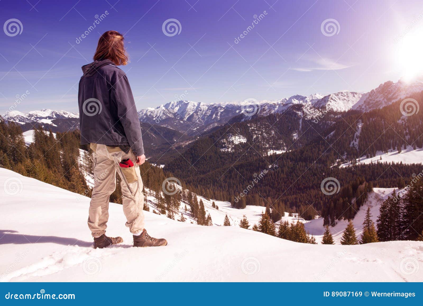 Young Man in the Snow Looking into the Distance Surrounded by Mo Stock ...