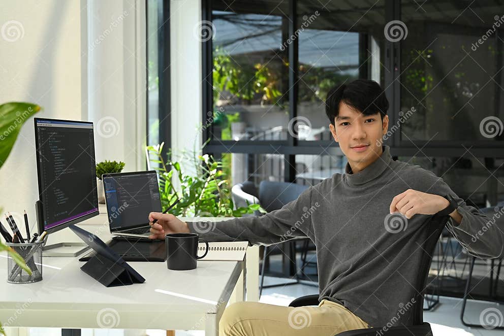Young Man Software Developers Working with Coded Data on Computer Screen. Developing Programming ...