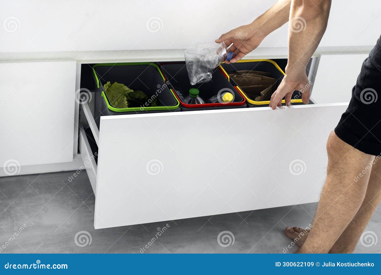 A Young Man Sorts Garbage in Containers in the Kitchen in Slow Motion ...
