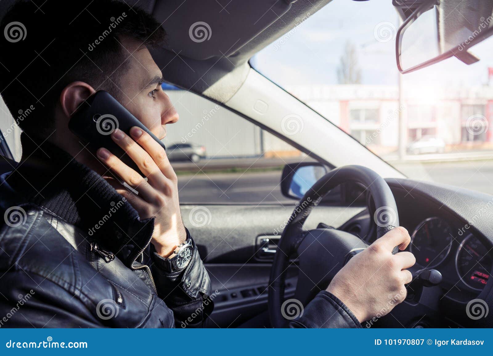 Young Man Speaking on the Mobile Phone while Driving a Car Stock Image ...
