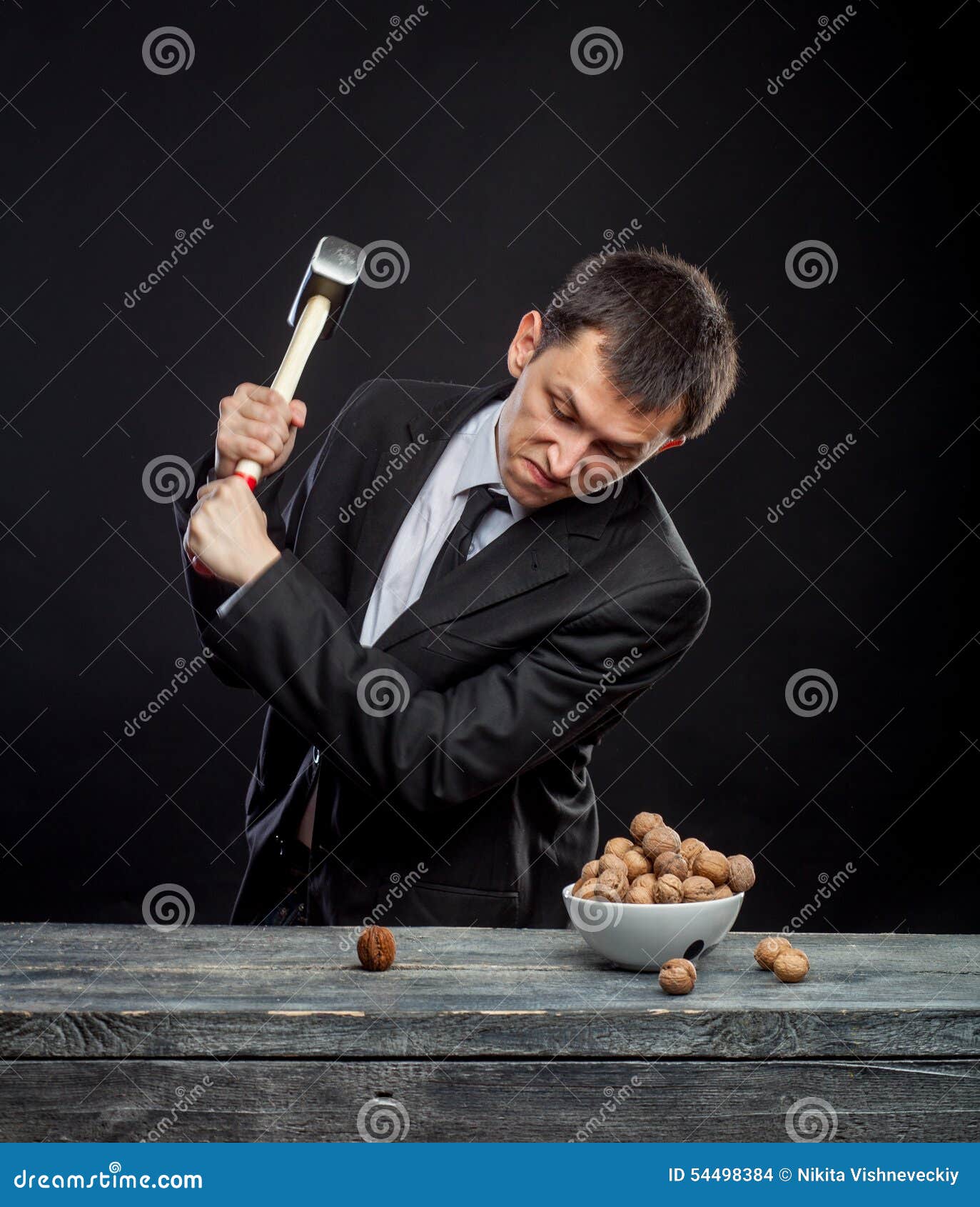 Young man stabs a nut stock photo. Image of male, expression - 54498384