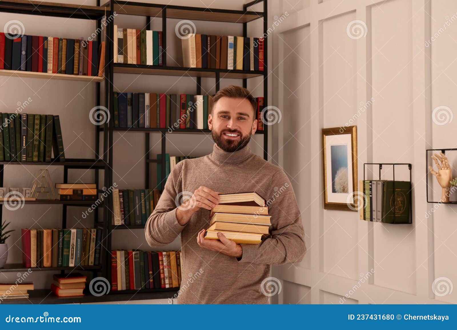 Young Man with Stack of Different Books in Home Library Stock Photo ...