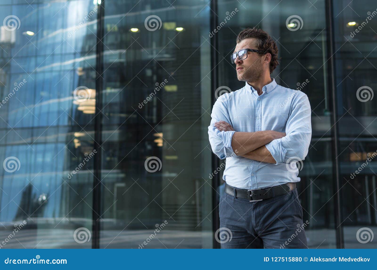 Young Man Standing Against Modern Building Stock Photo - Image of ...
