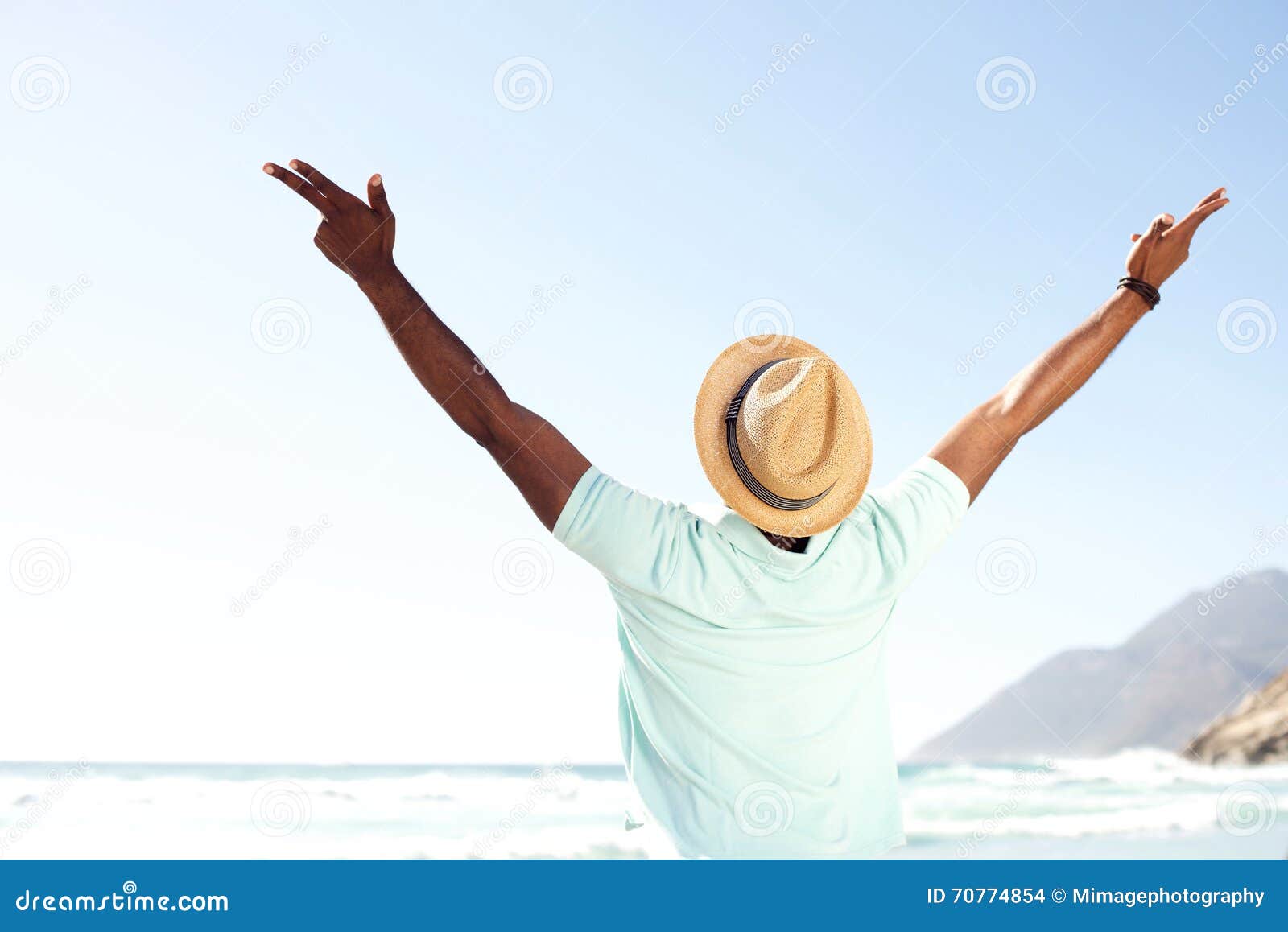 Young Man Standing with Arms Spread Open at Beach Stock Photo - Image ...
