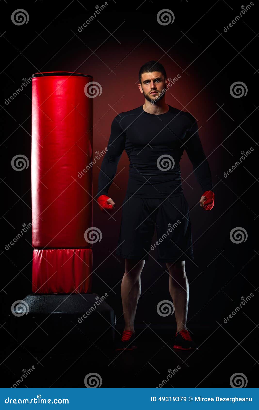 Young Man Standing by Boxing Bag in Studio Stock Image - Image of ...