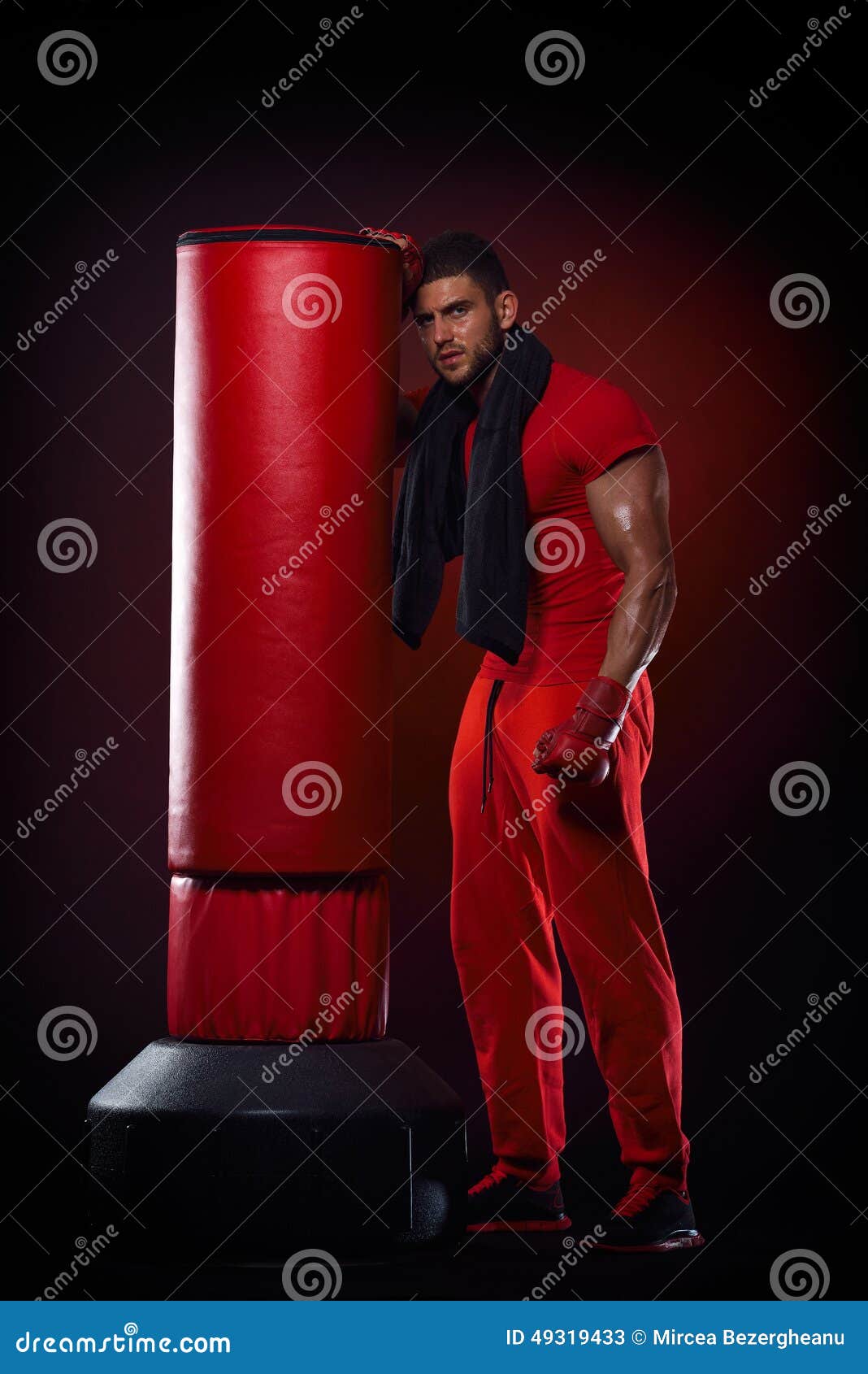 Young Man Standing by Boxing Bag in Studio Stock Image - Image of ...