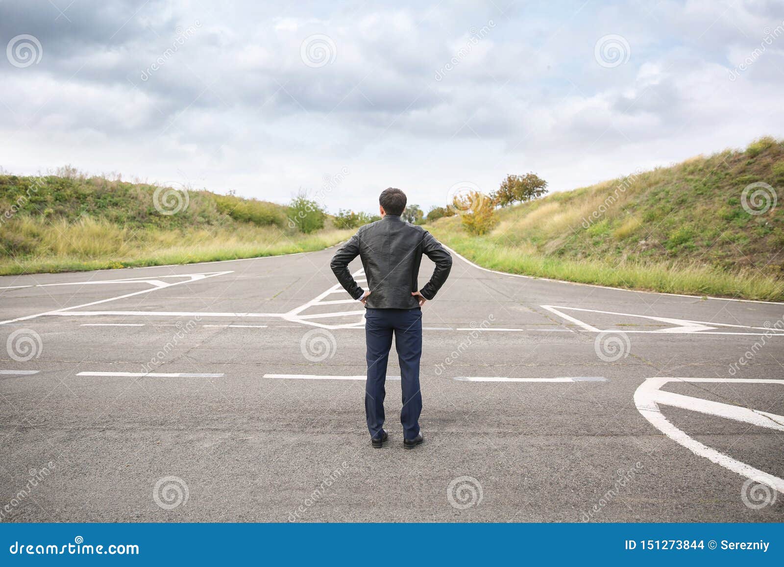 Young Man Standing at Crossroads. Concept of Choice Stock Photo - Image ...