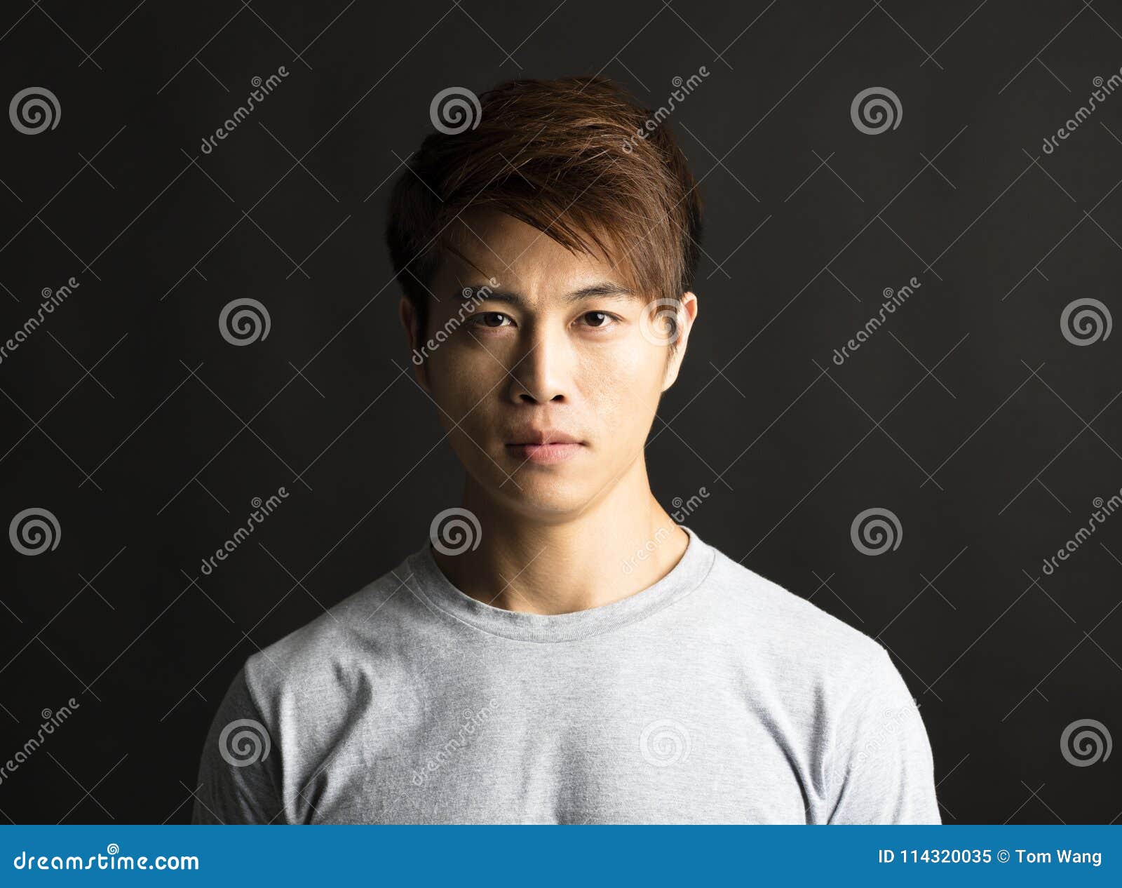 Young Man Standing in Front of Black Background Stock Image - Image of ...