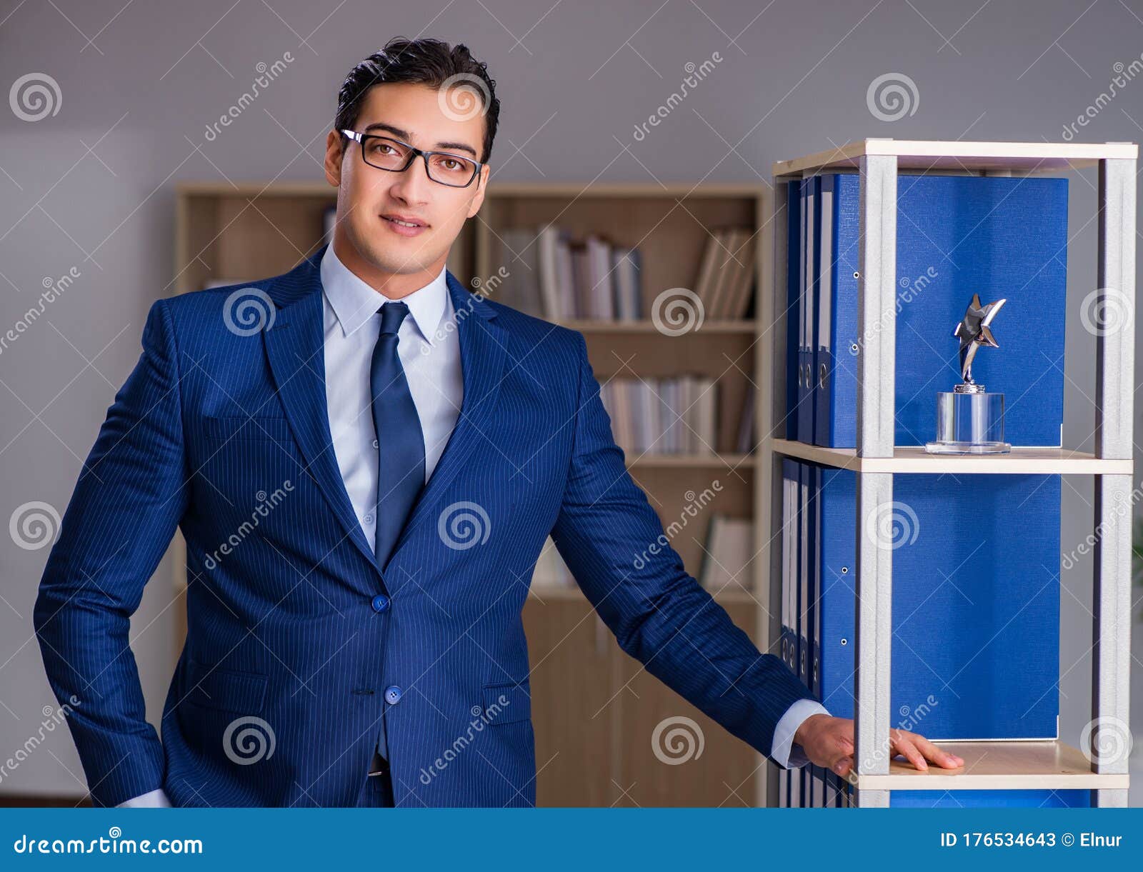 Young Man Standing Next To the Shelf with Folders Stock Image - Image ...