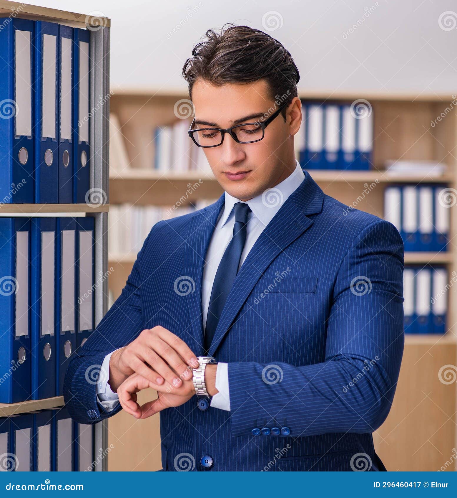 Young Man Standing Next To the Shelf with Folders Stock Image - Image ...