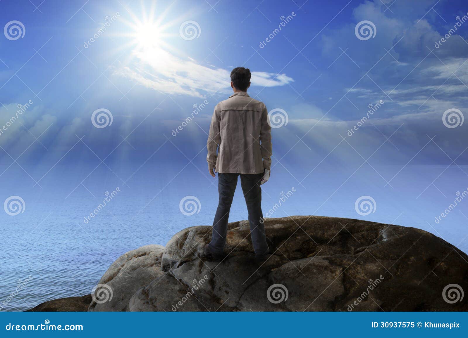 Young Man Standing on Rock Mountain and Looking To the Sun Stock Image ...