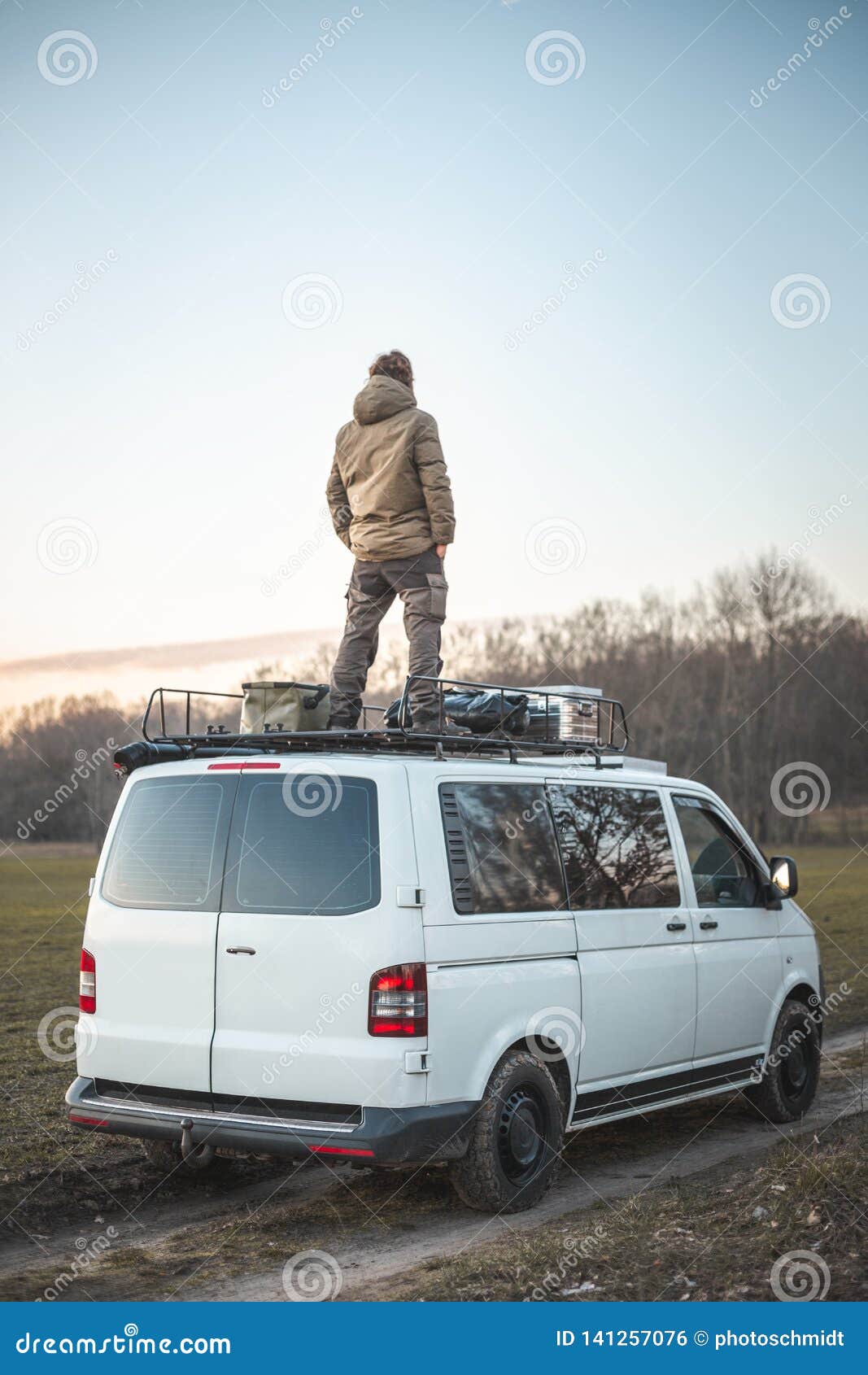 Young Man Standing on the Roof of a Van Stock Photo - Image of averted ...