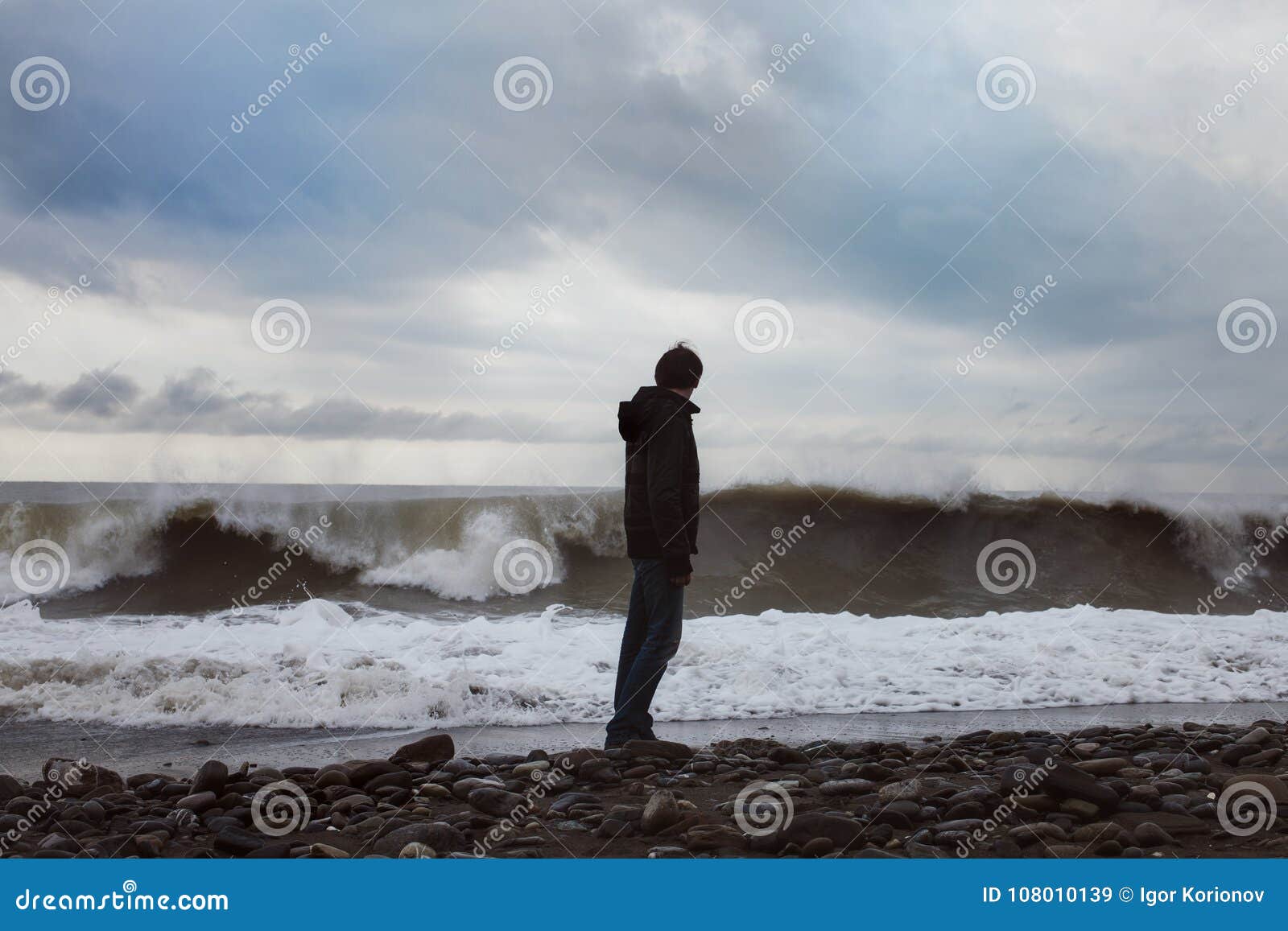 Young Man Standing on the Sea Shore Stock Image - Image of fearlessness ... Young Man Standing on the Sea Shore Stock Image - Image of fearlessness ...