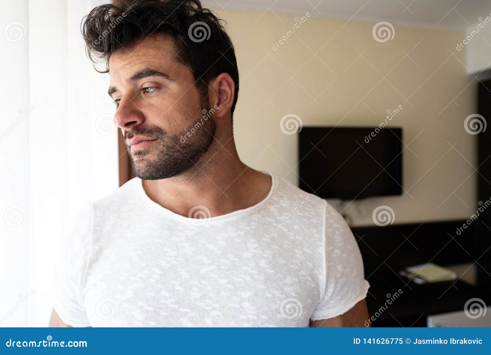Man Standing at Window Looking Out Over City Stock Image - Image of ...
