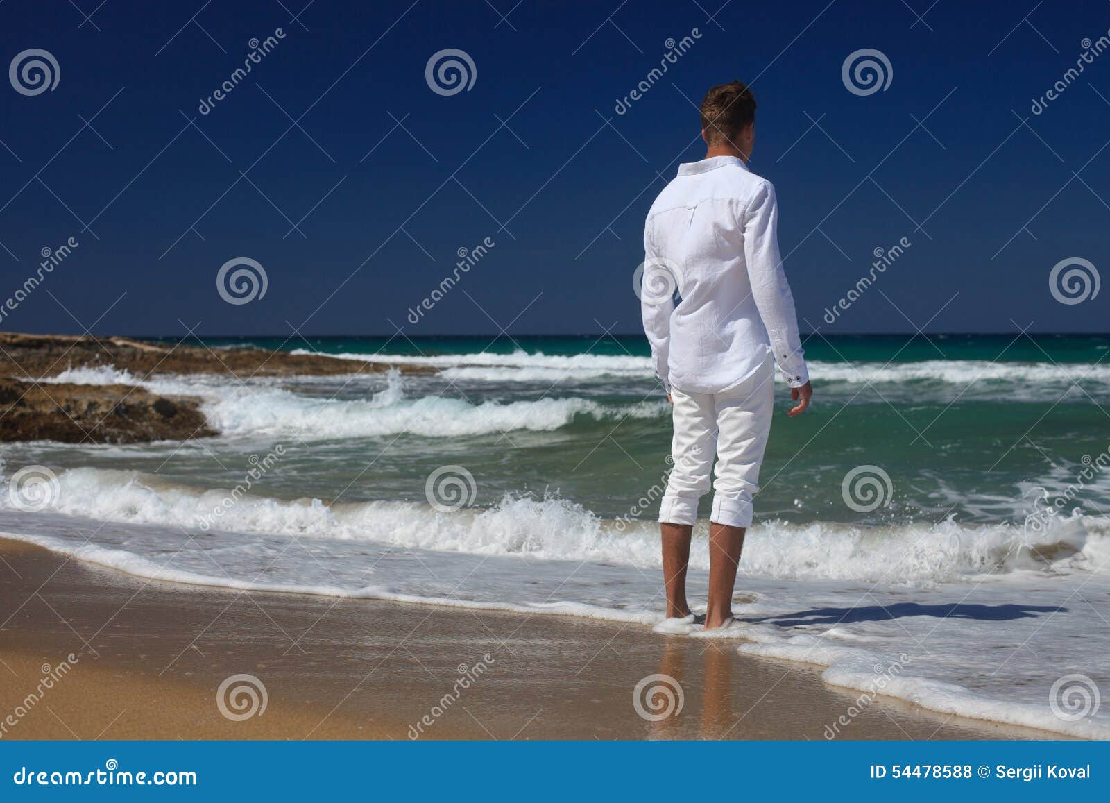 A Young Man Stands with His Back on the Beach Stock Photo - Image of ...