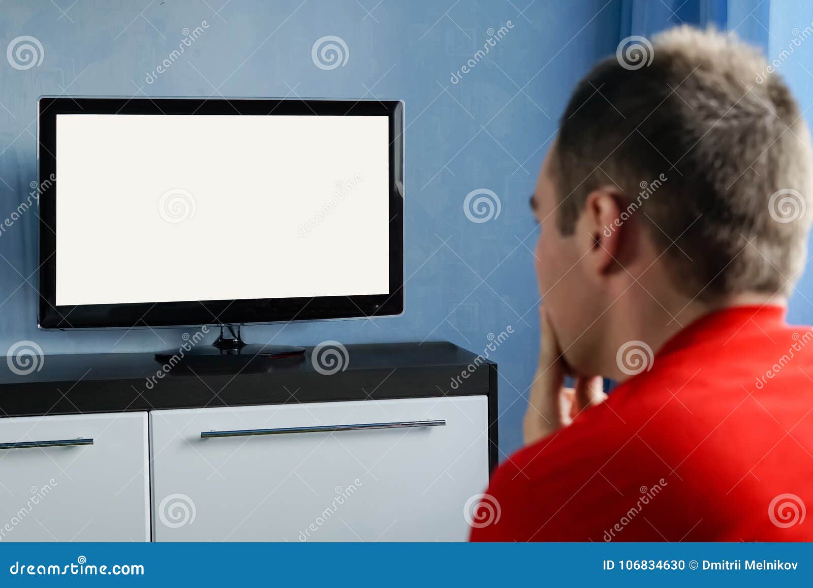 The Young Man Stares at the TV. Blank Screen White Screen Stock Photo ...