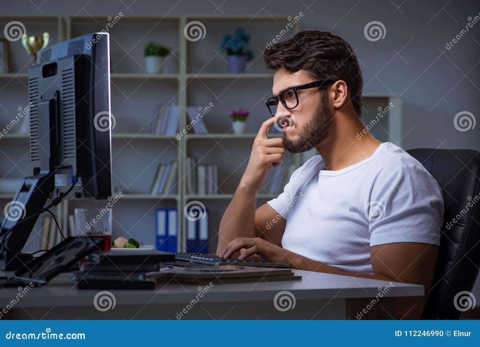 The Young Man Staying Late in Office To Do Overtime Work Stock Photo ...