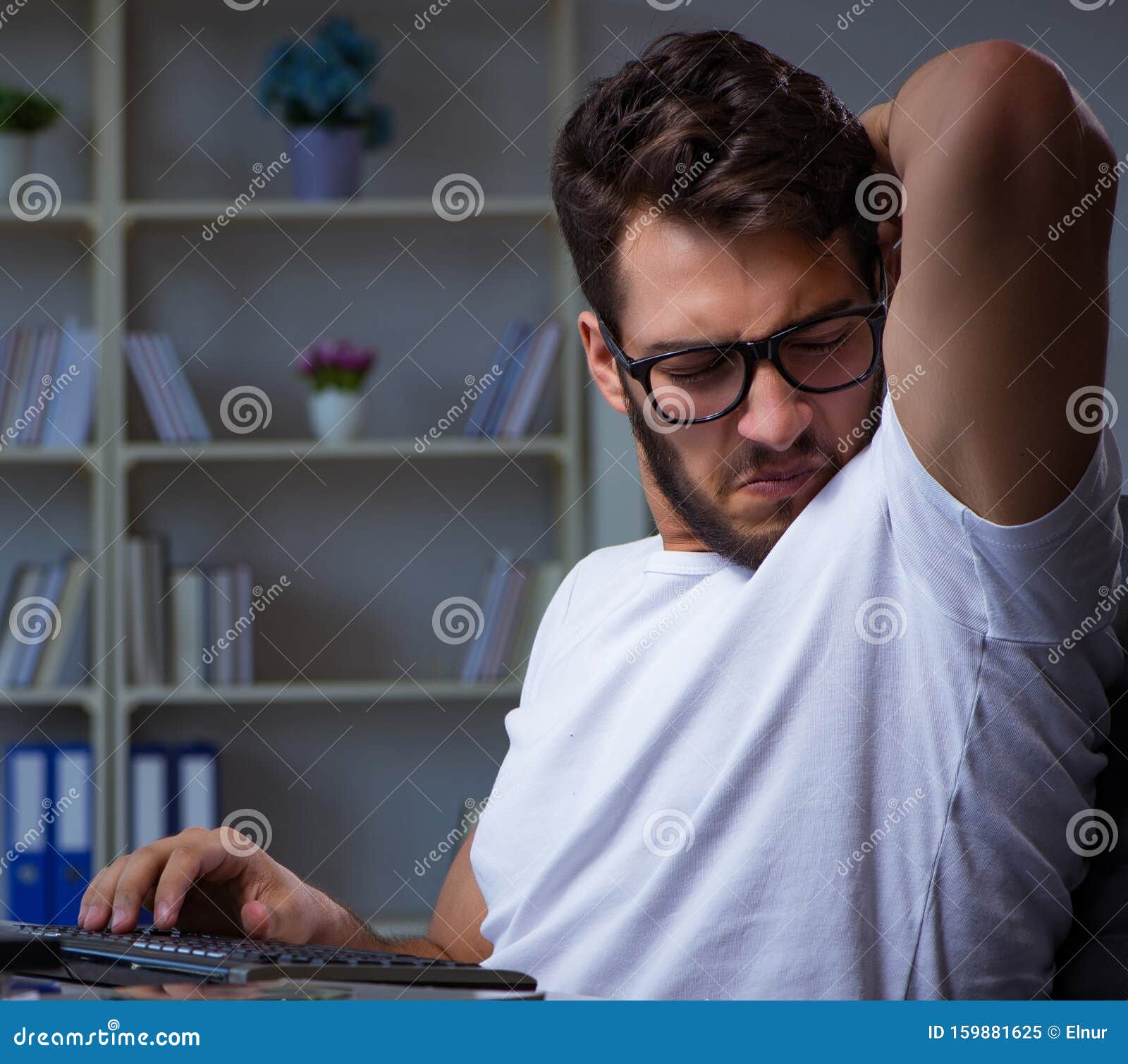Young Man Staying Late in Office To Do Overtime Work Stock Image ...
