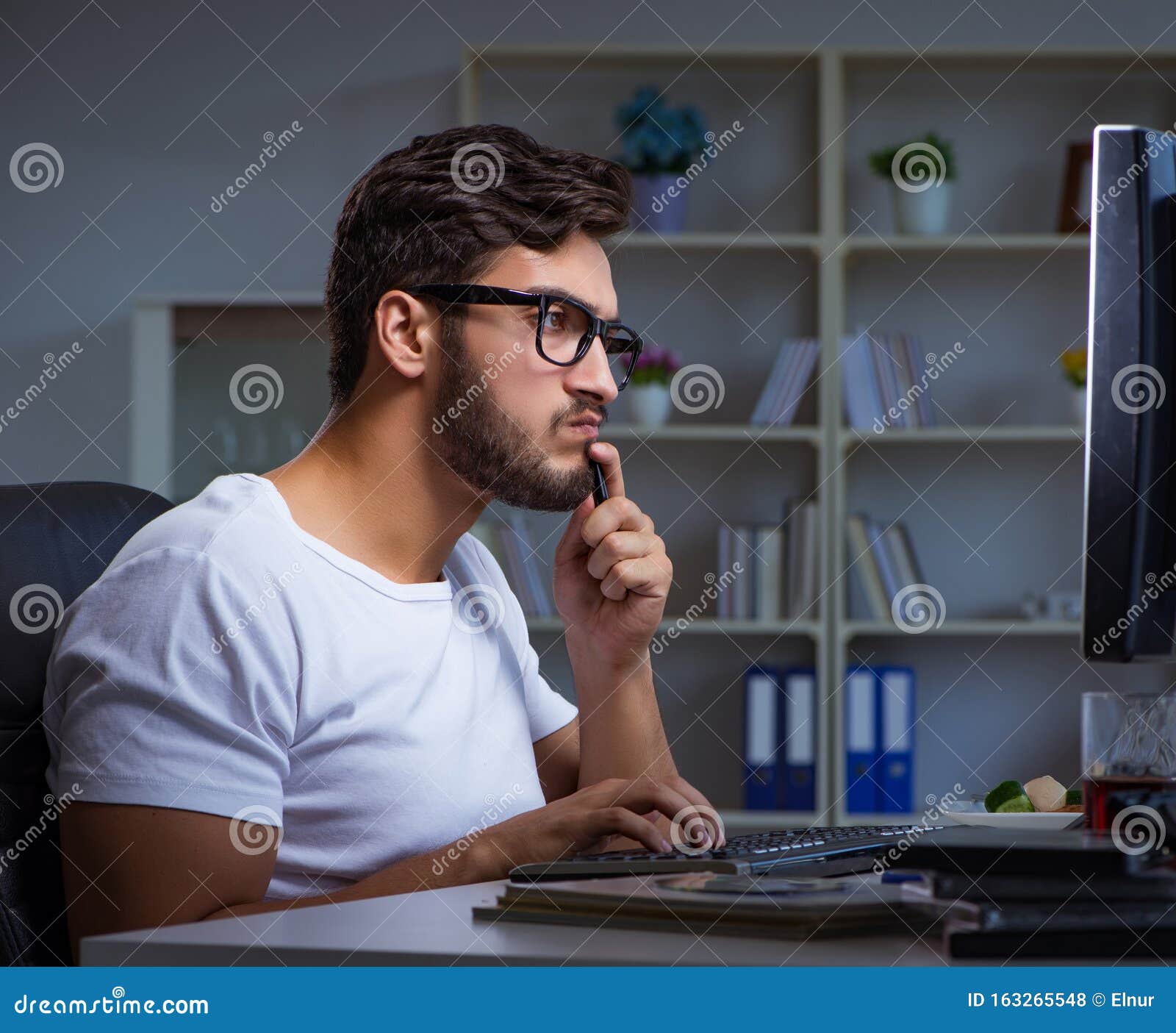 Young Man Staying Late in Office To Do Overtime Work Stock Photo ...