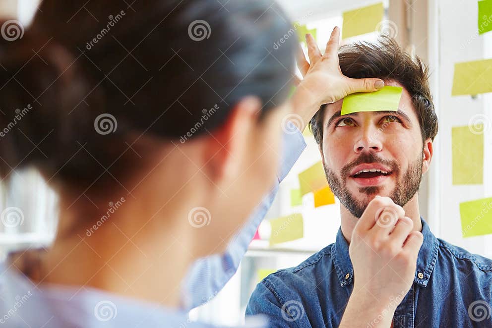 Young Man with Sticky Note on Forehead Stock Photo - Image of business ...