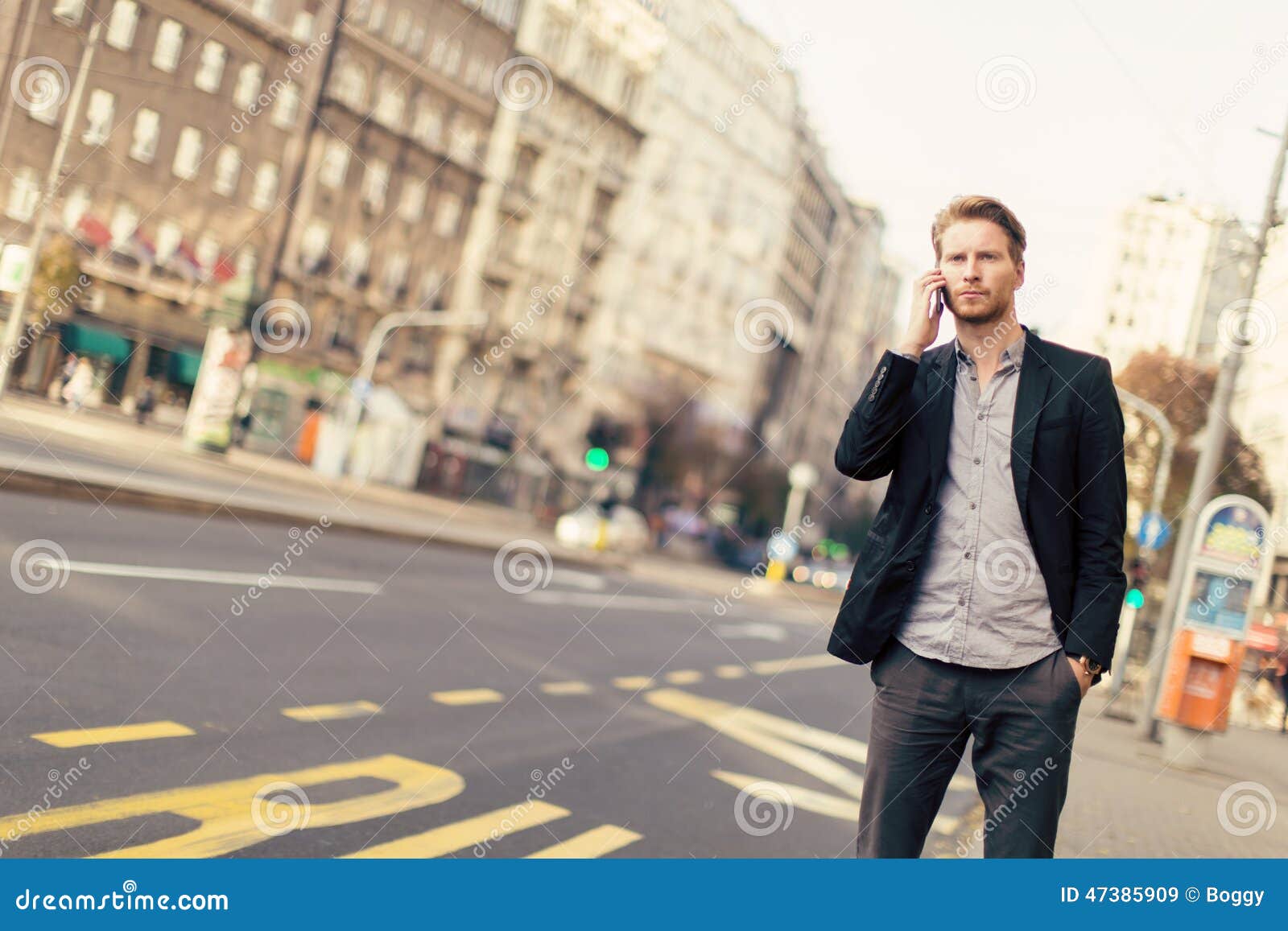 Young Man on the Street with Mobile Phone Stock Image - Image of ...
