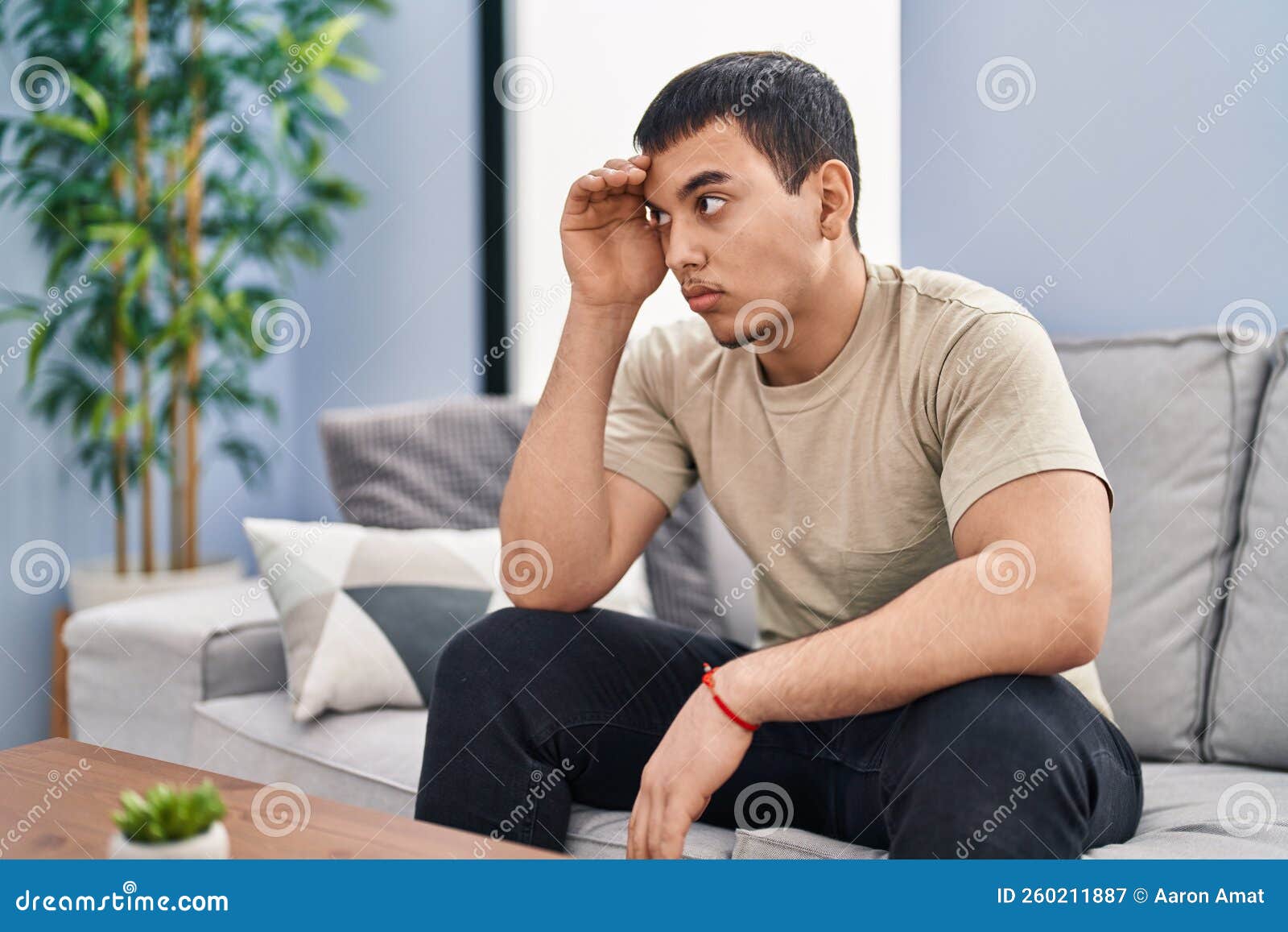 Young Man Stressed Sitting on Sofa at Home Stock Image - Image of ...