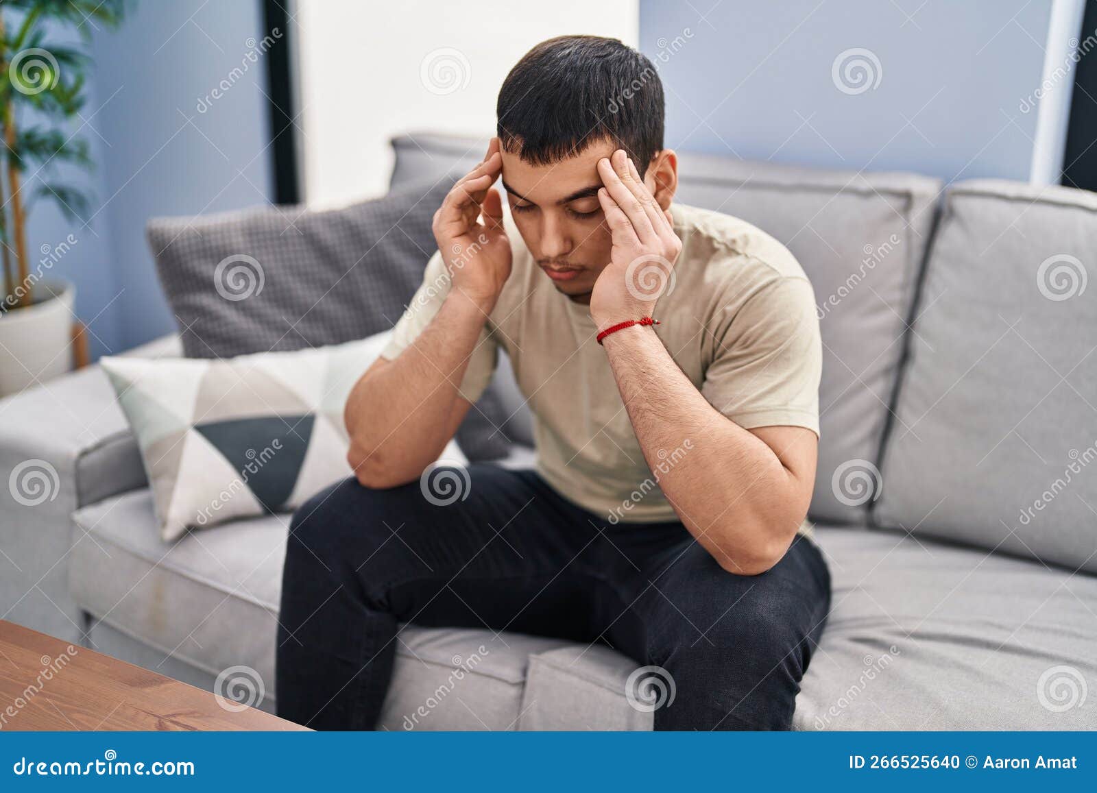 Young Man Stressed Sitting on Sofa at Home Stock Photo - Image of male ...