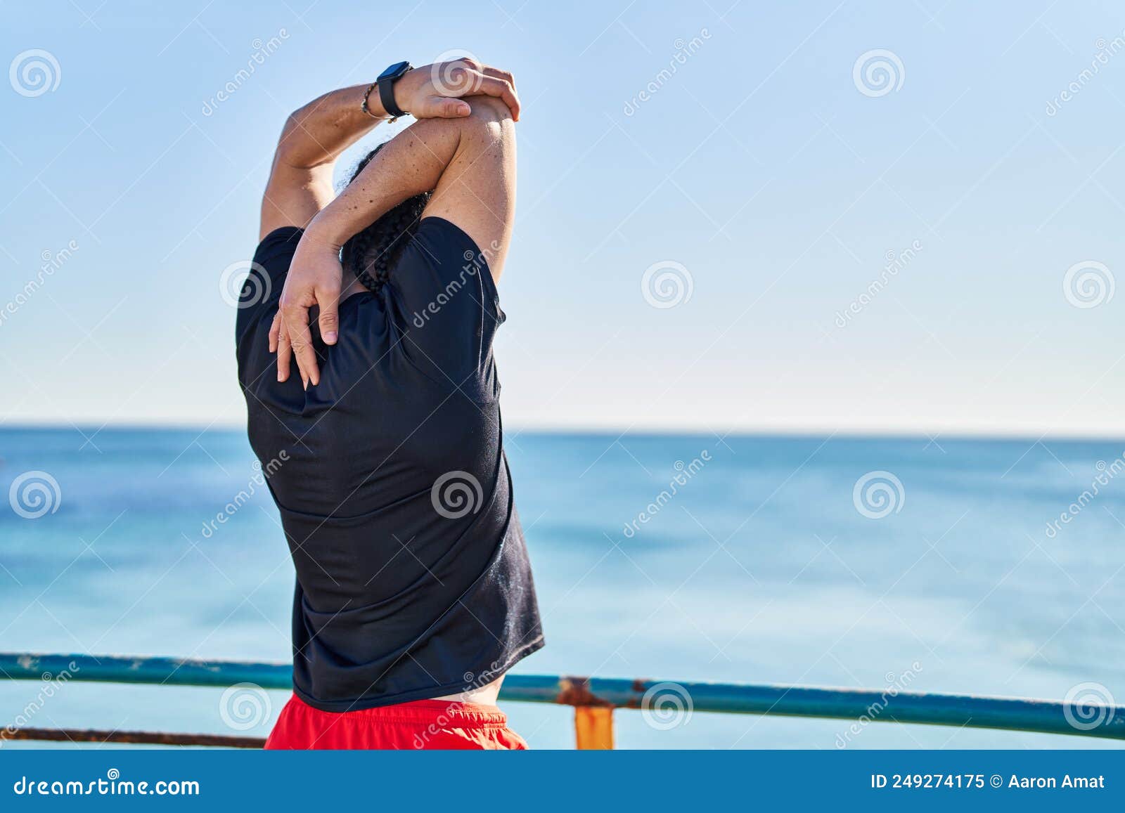 Young Man Stretching Arms on Back View at Seaside Stock Image - Image ...