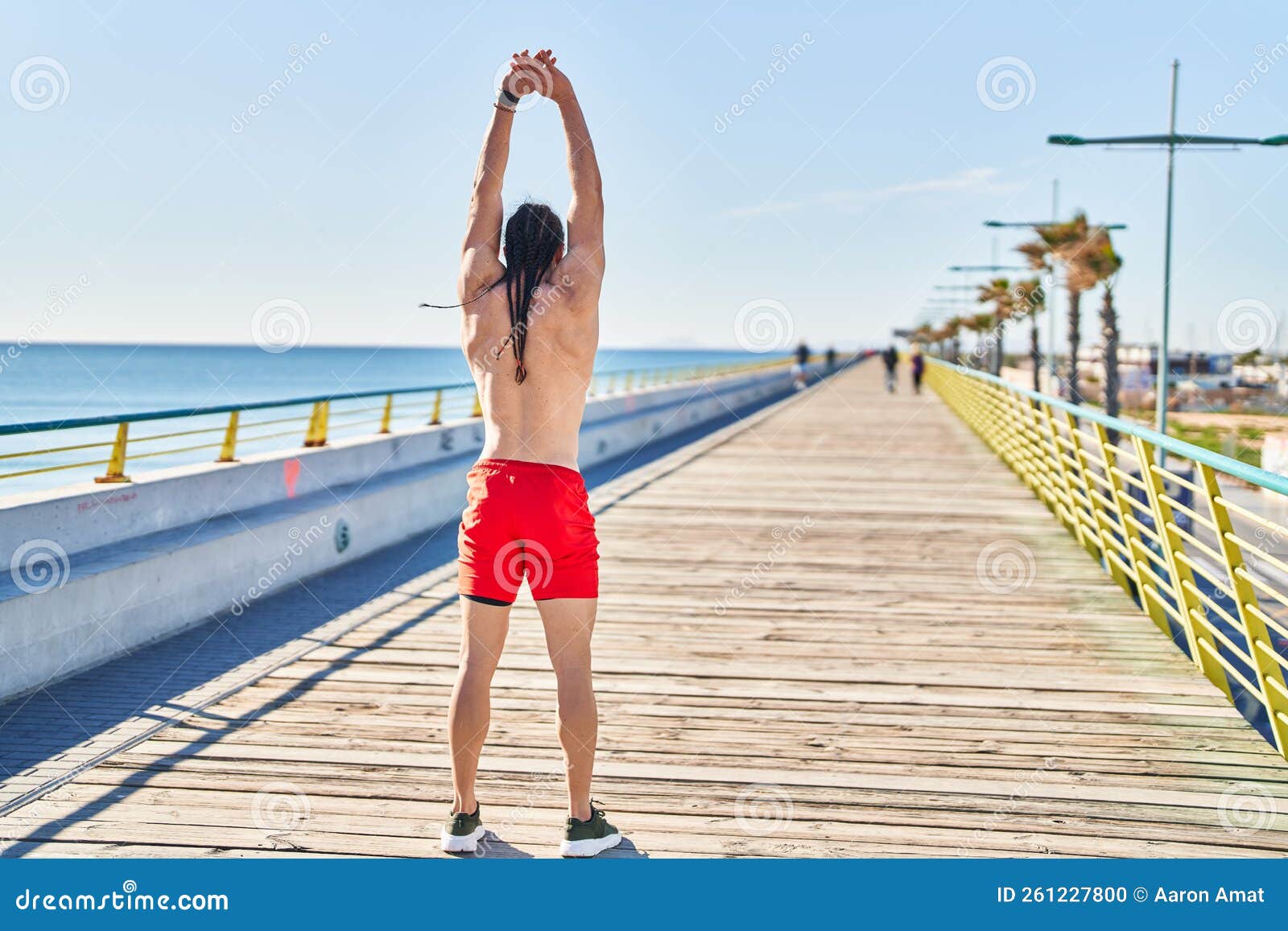 Young Man Stretching Arms on Back View at Seaside Stock Photo - Image ...