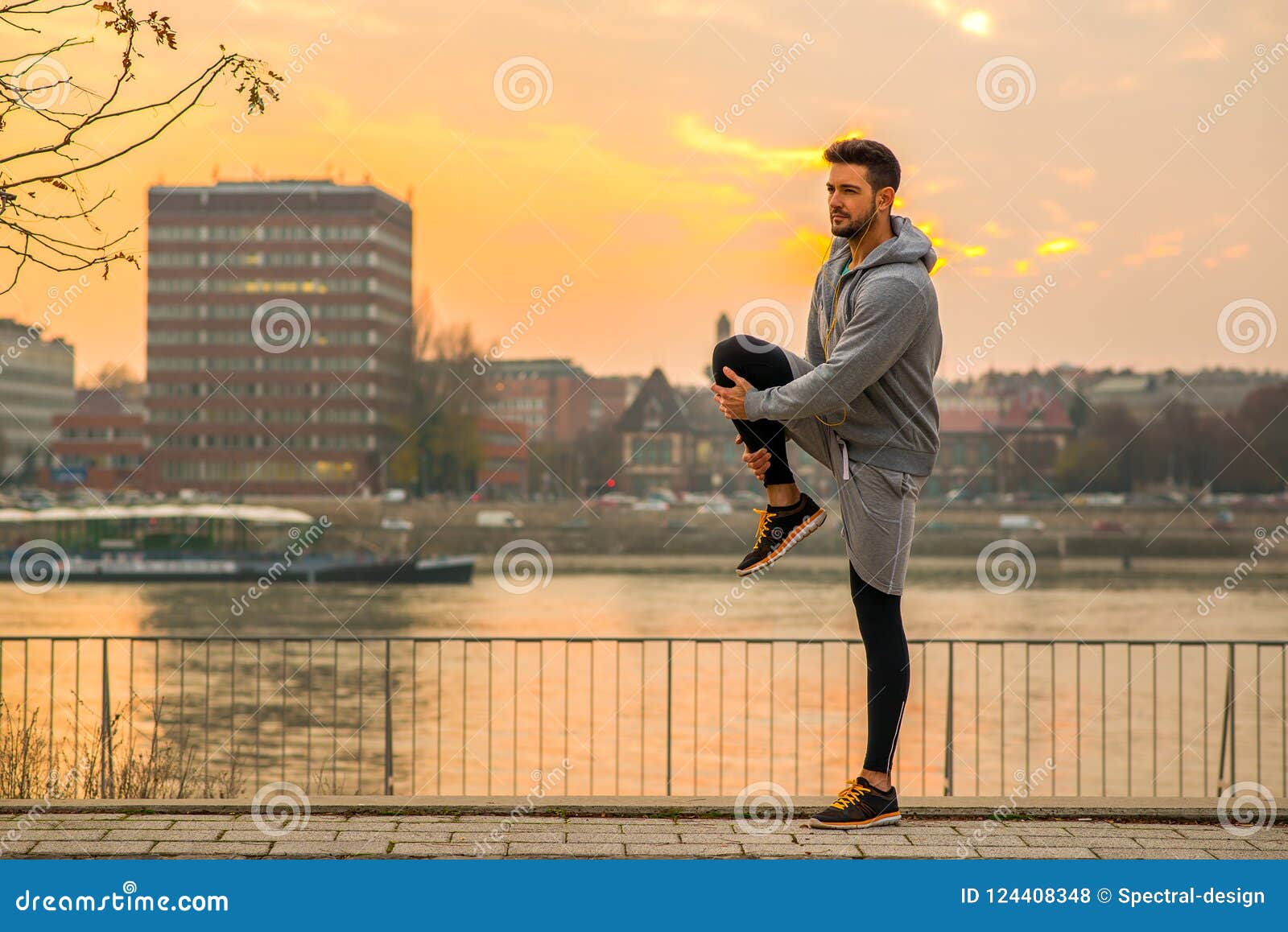 Young man stretching stock photo. Image of jogger, city - 124408348