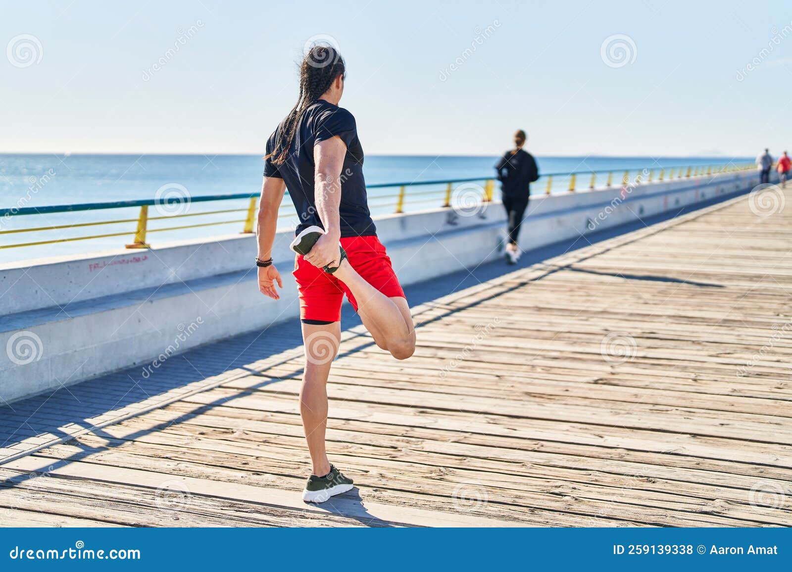 Young Man Stretching Legs on Back View at Seaside Stock Photo - Image ...