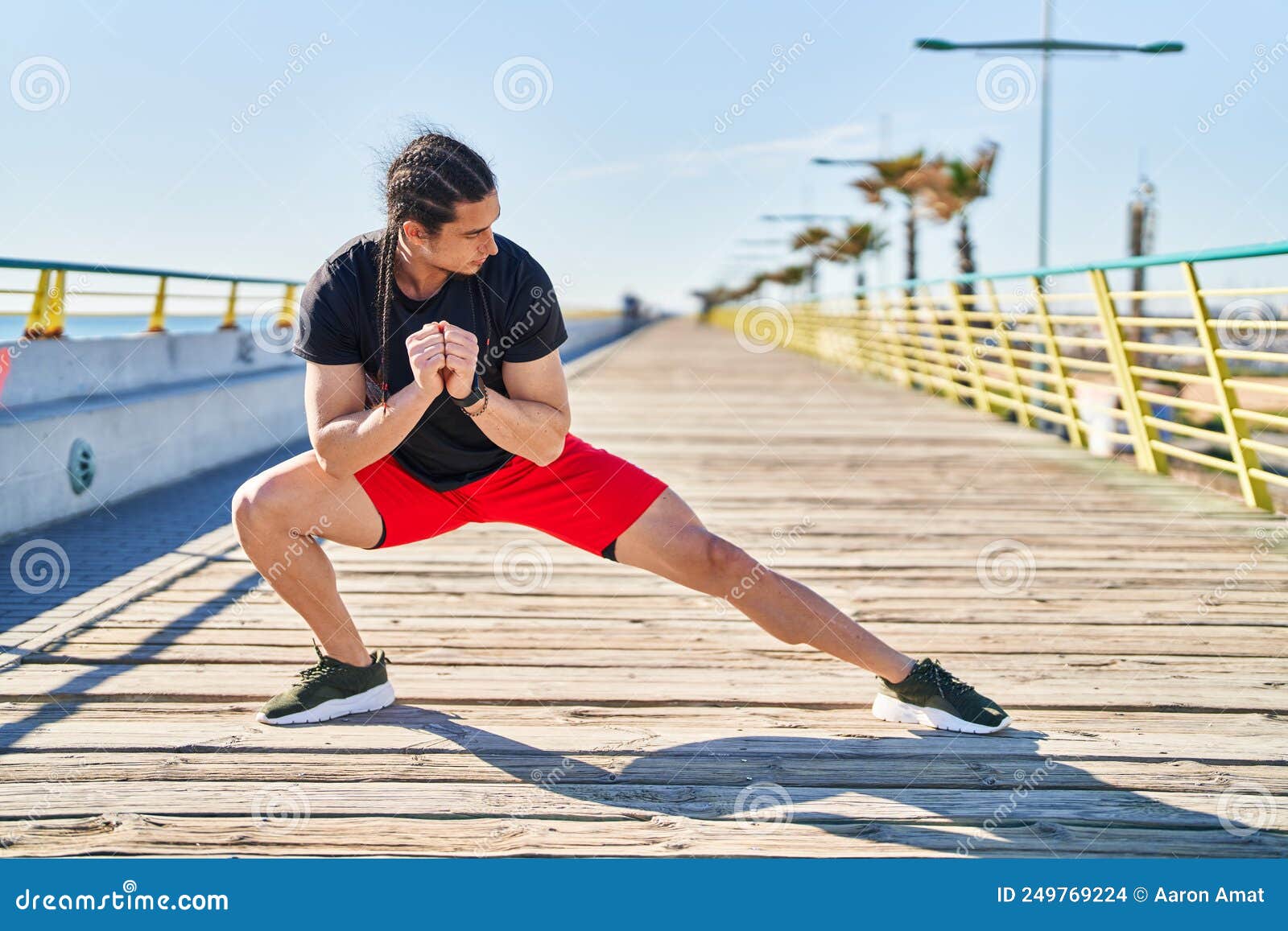 Young Man Stretching Legs at Seaside Stock Photo - Image of sunny ...