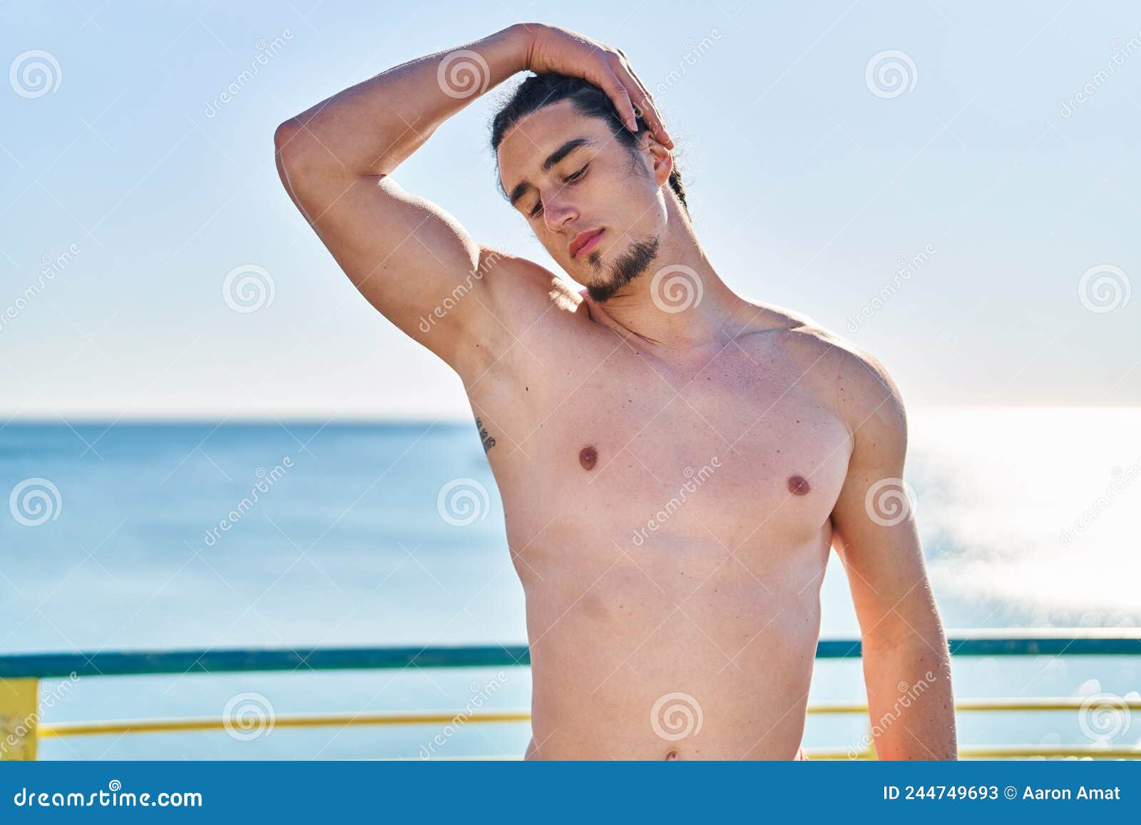 Young Man Stretching Neck at Seaside Stock Image - Image of casual ...