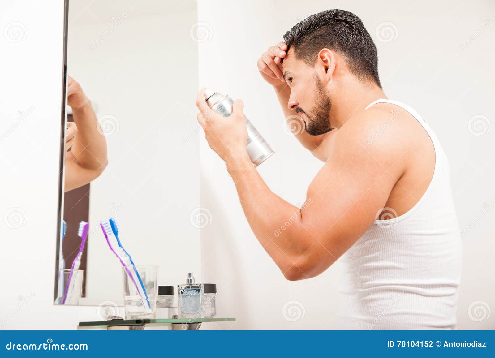 Young Man Styling His Hair with Spray Stock Photo - Image of single ...